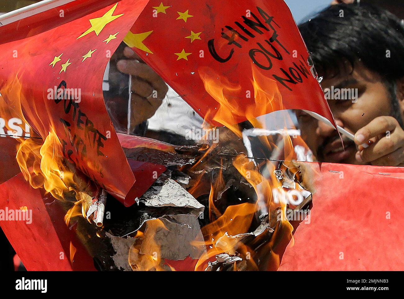 A protester burns mock Chinese flags at Manila's Rizal park ...