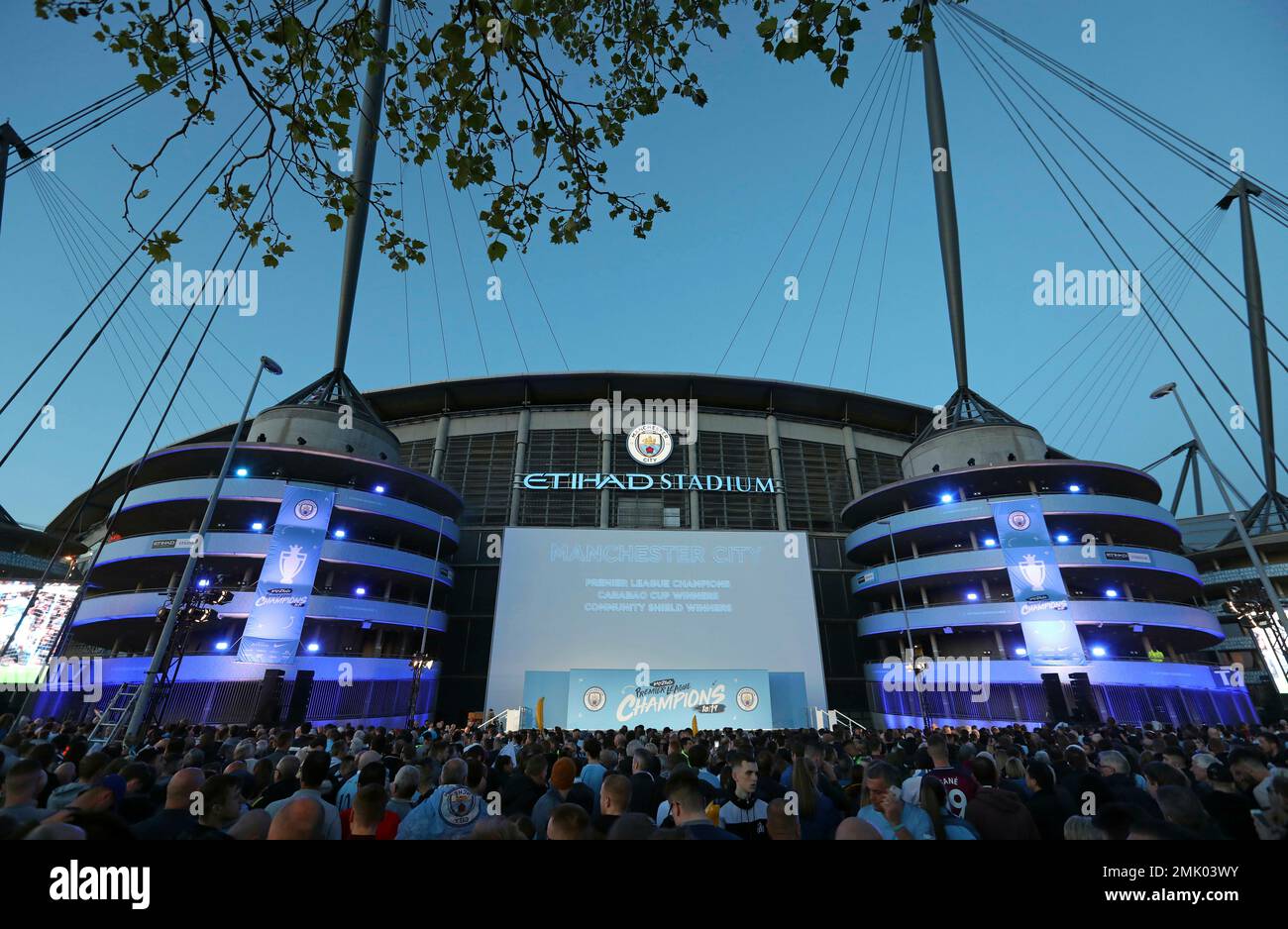 Manchester City supporters gather as they await the arrival of the team ...