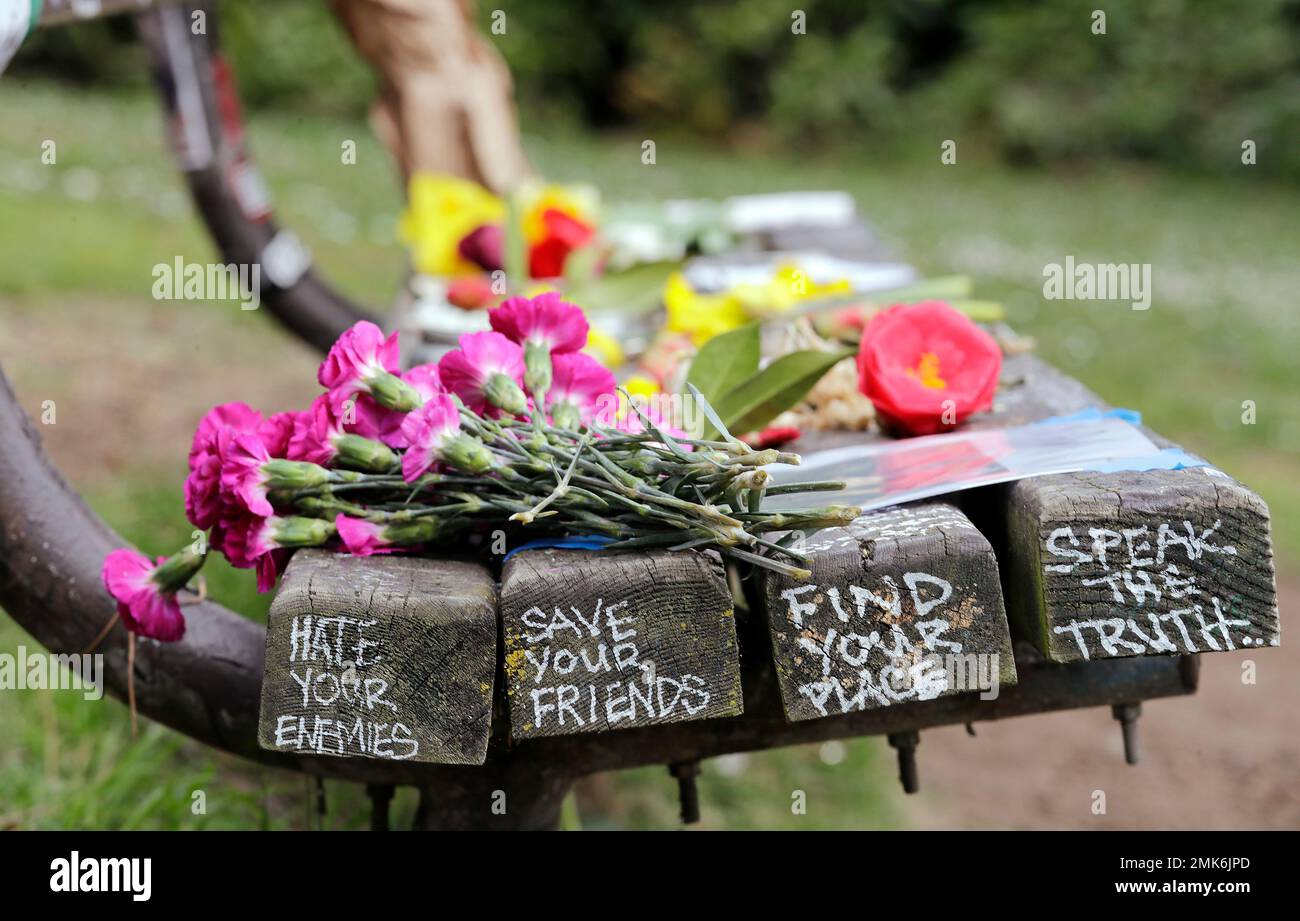 Flowers honoring the late Kurt Cobain appear on a park bench, Friday ...