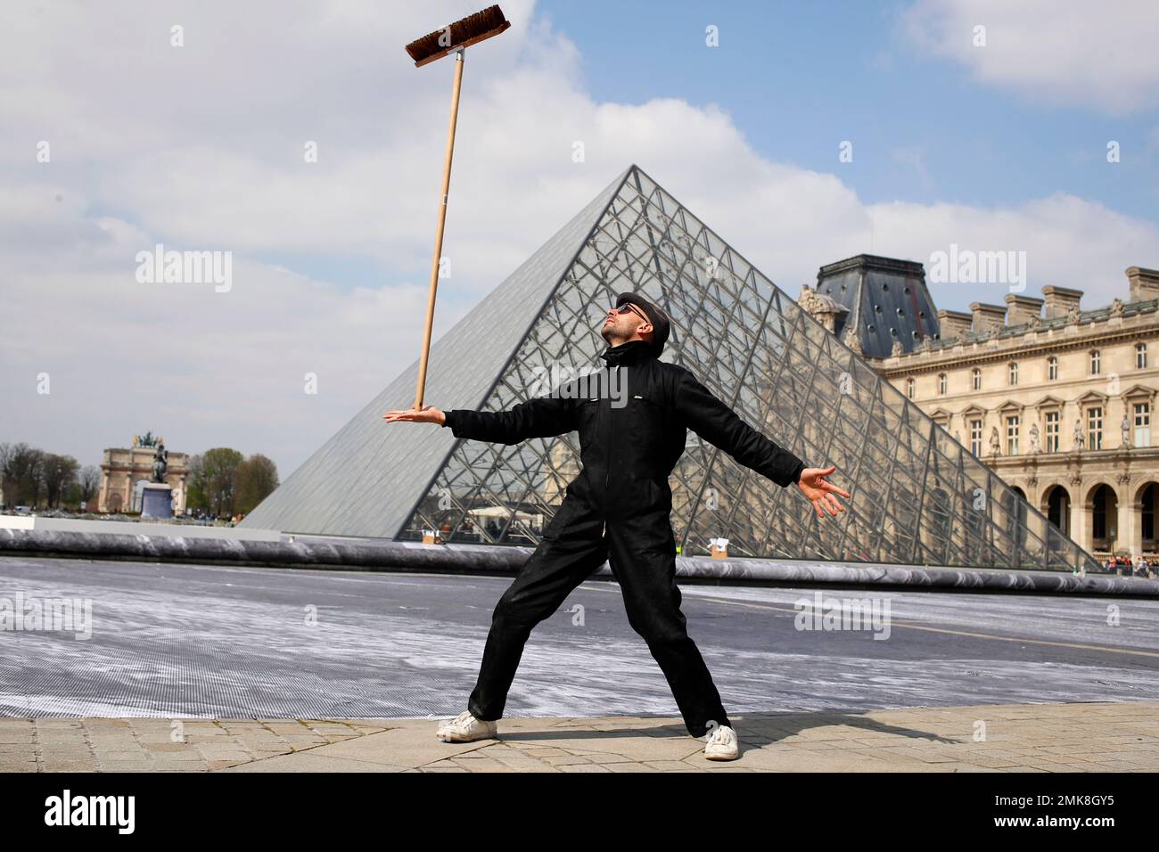 French street artist JR poses in the courtyard of the Louvre Museum ...