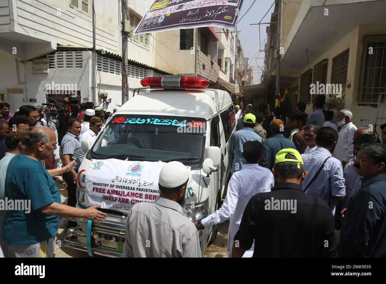 People surround an ambulance carrying the body of shooting victim Syed ...