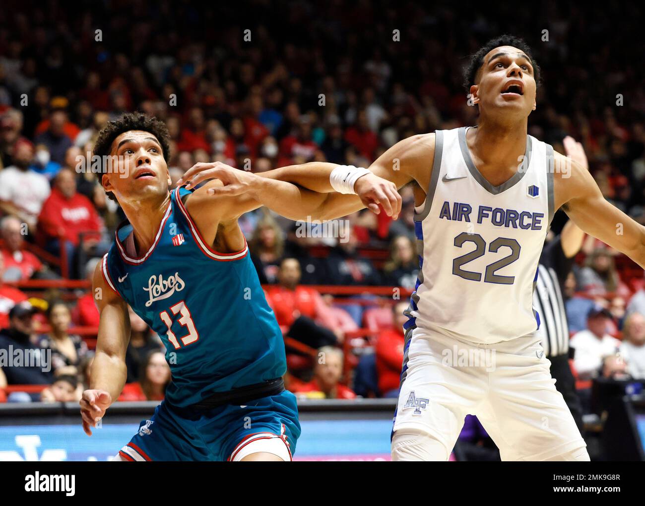 New Mexico guard Javonte Johnson, left, and Air Force forward Nikc ...