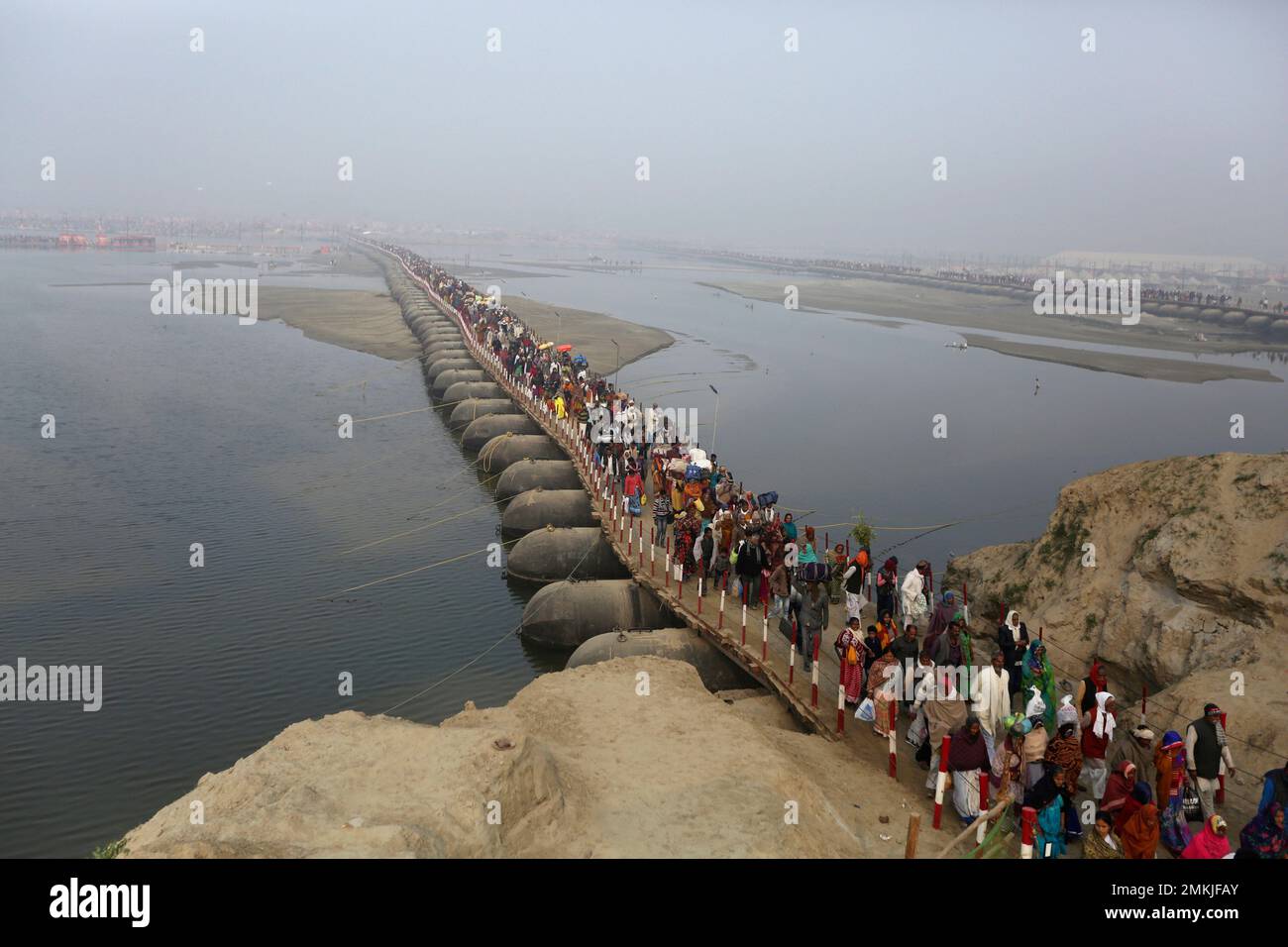 Indian Hindu pilgrims walk through a pontoon bridge on the eve of Mauni ...