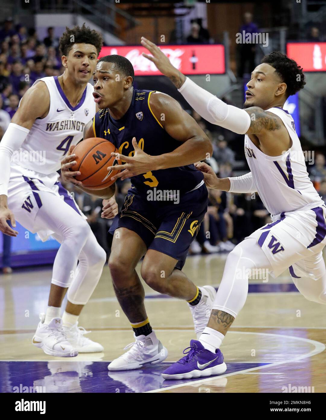 California's Paris Austin (3) drives between Washington's Matisse ...