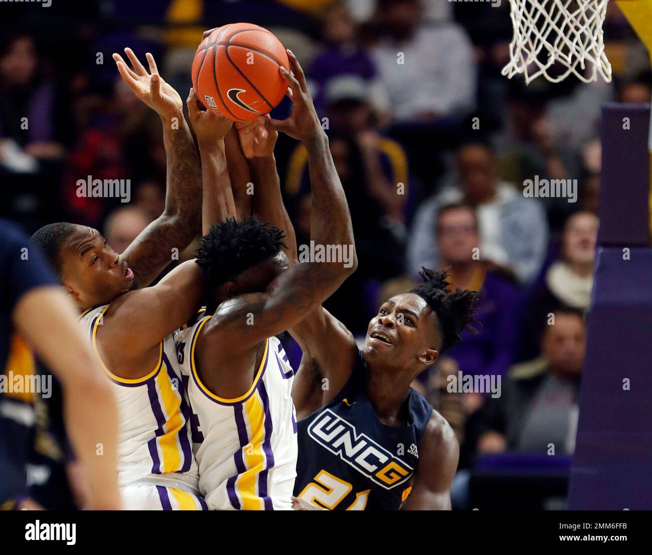 UNC Greensboro forward James Dickey (21) battles under the basket with ...