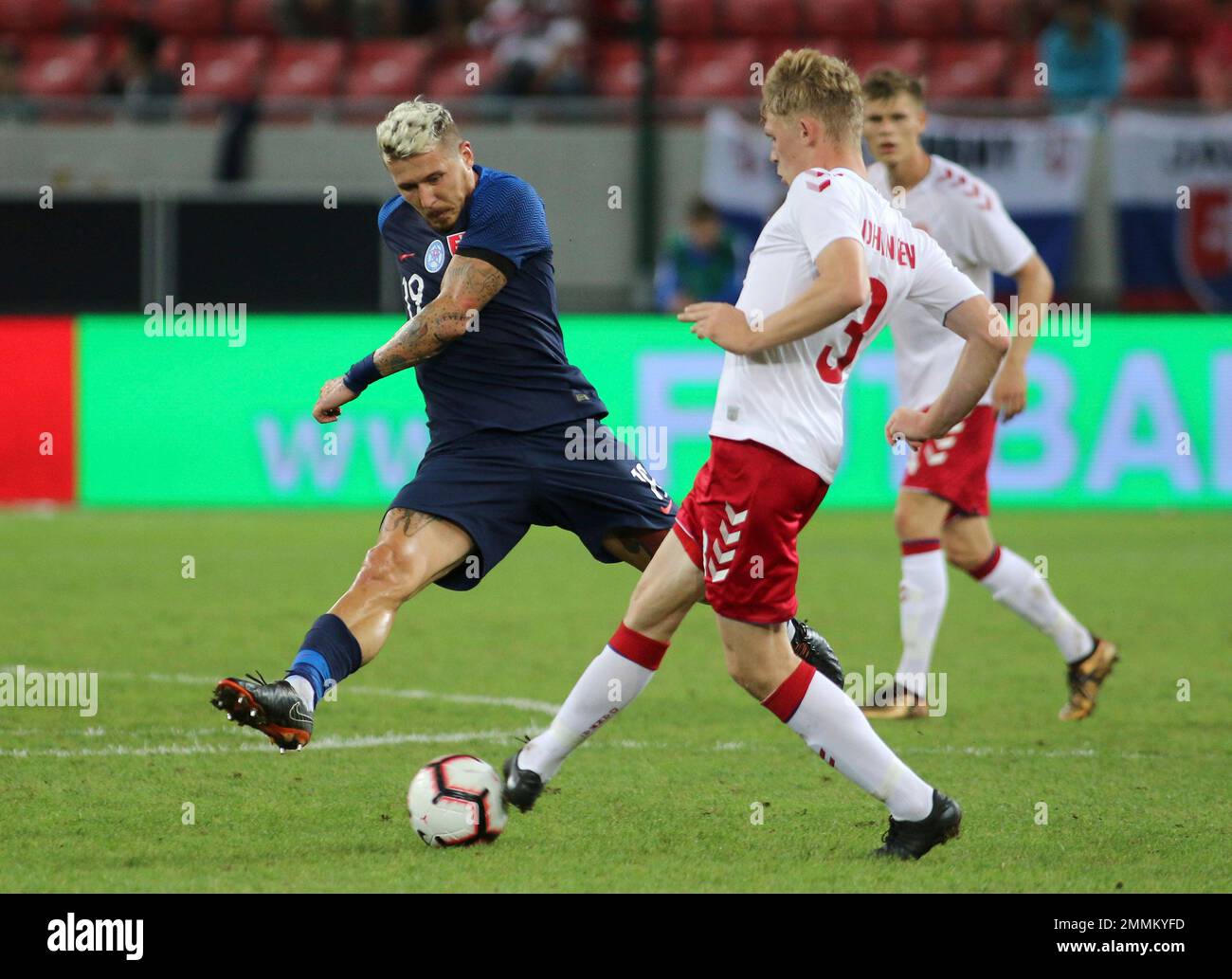 Denmark's Nicolai Johansen, right, and Slovakia's Juras Kucka challenge ...
