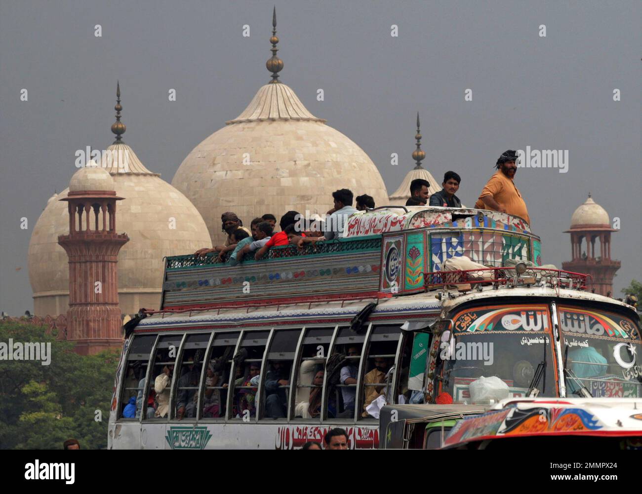 People ride on a crowded passenger bus to reach their villages and ...