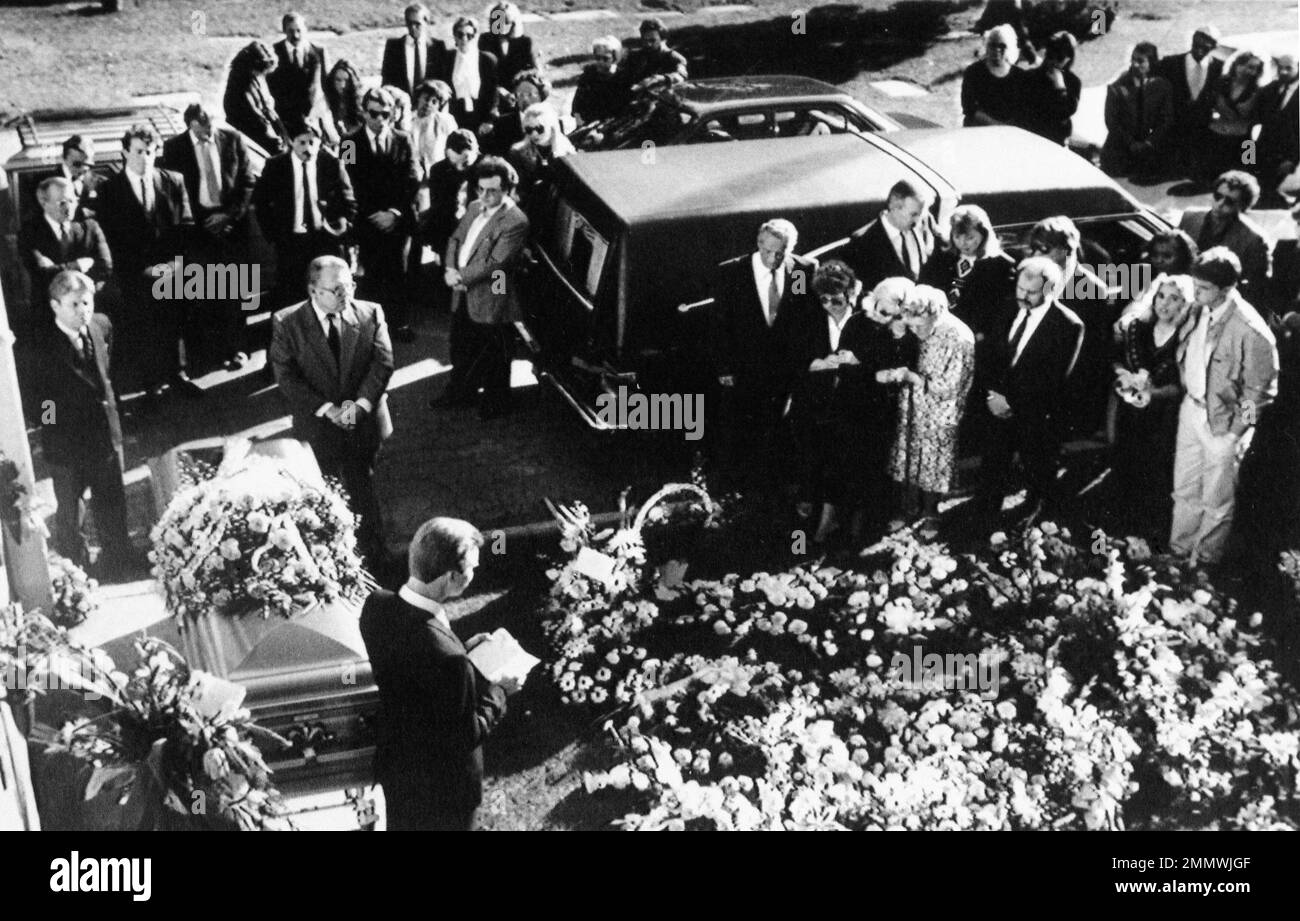 Family and friends look on during funeral services for 12-year-old ...