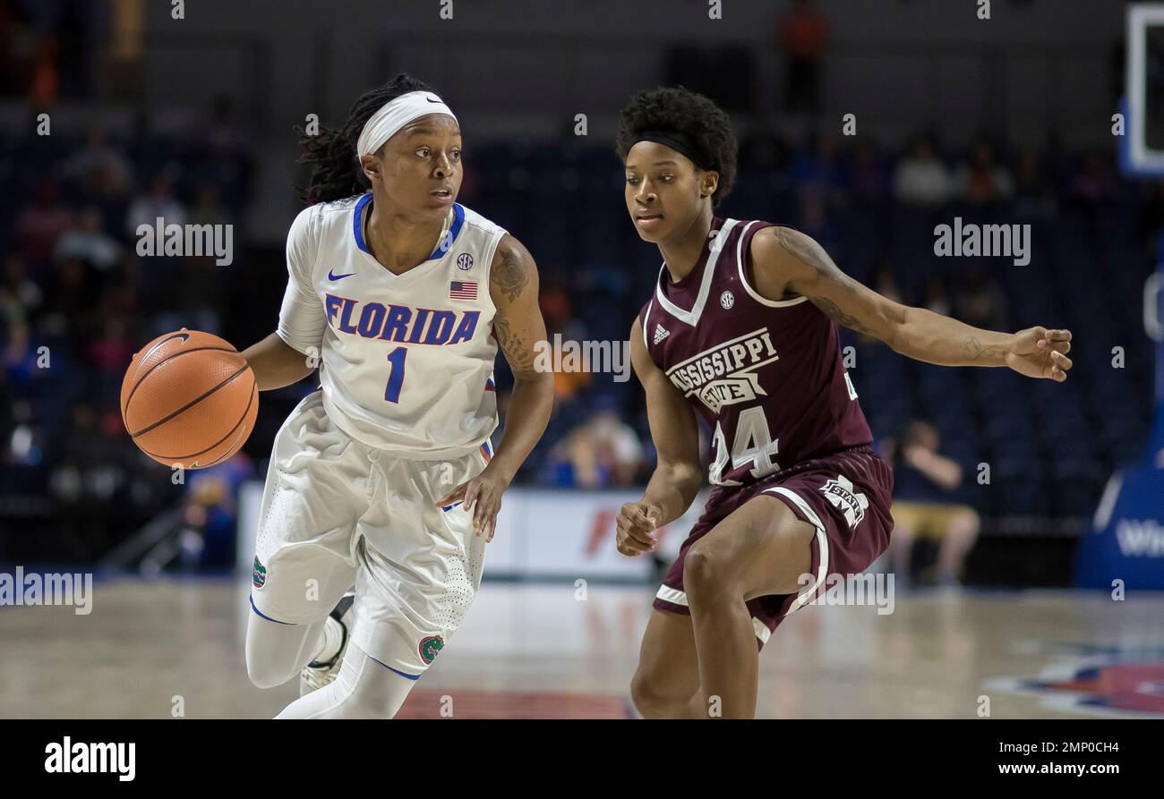 Florida guard Tameria Johnson (1) dribbles past Mississippi State guard ...
