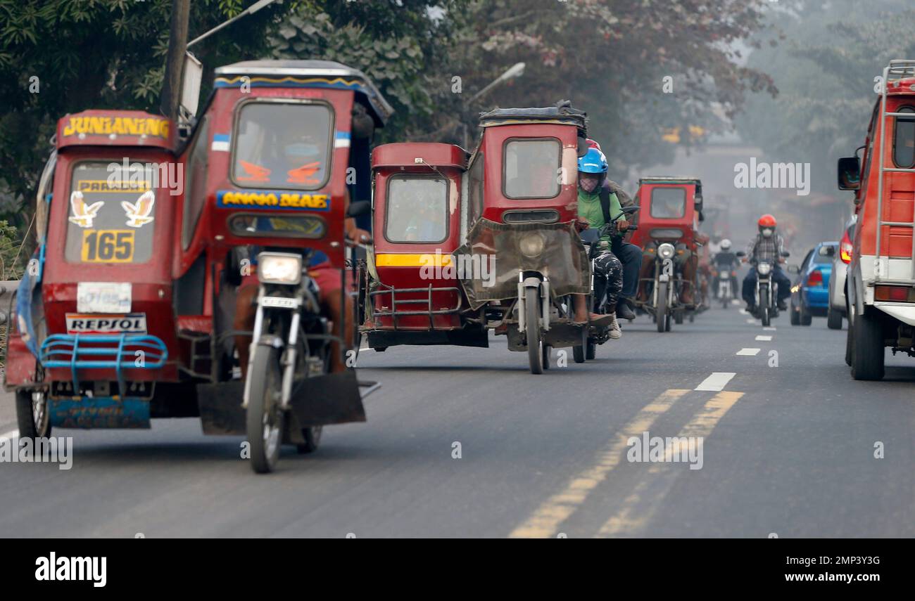 Motorists use face masks as volcanic ash from Mayon volcano's eruption ...