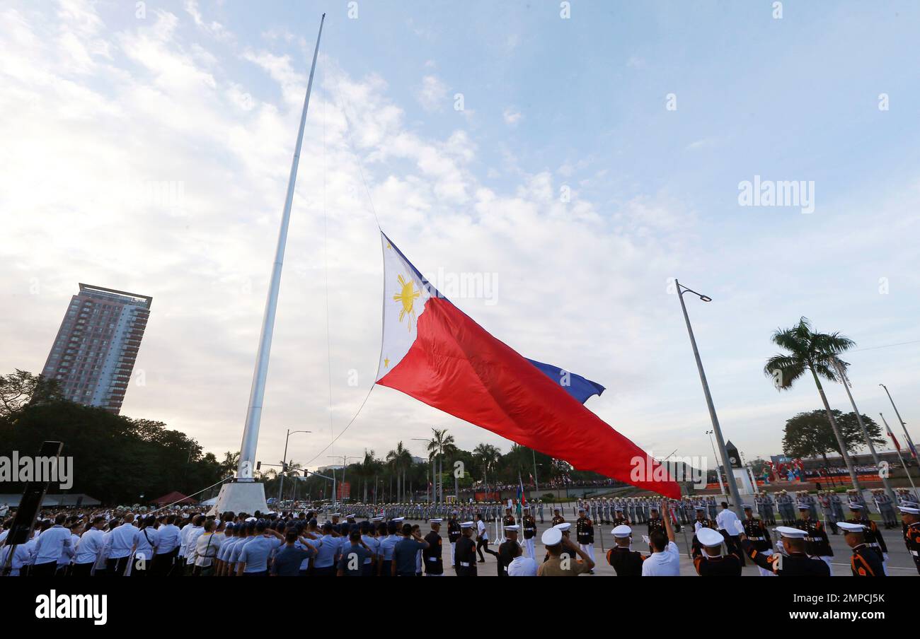 Philippine President Rodrigo Duterte leads flag-raising rites at the ...