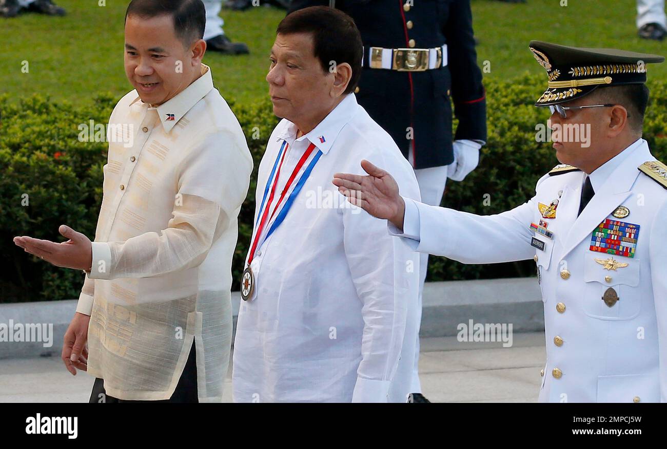 Philippine President Rodrigo Duterte, center, follows a wreath during a ...