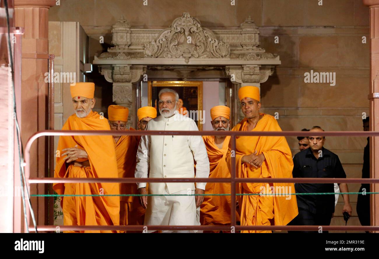 Indian Prime Minister Narendra Modi, center, walks accompanied by head ...