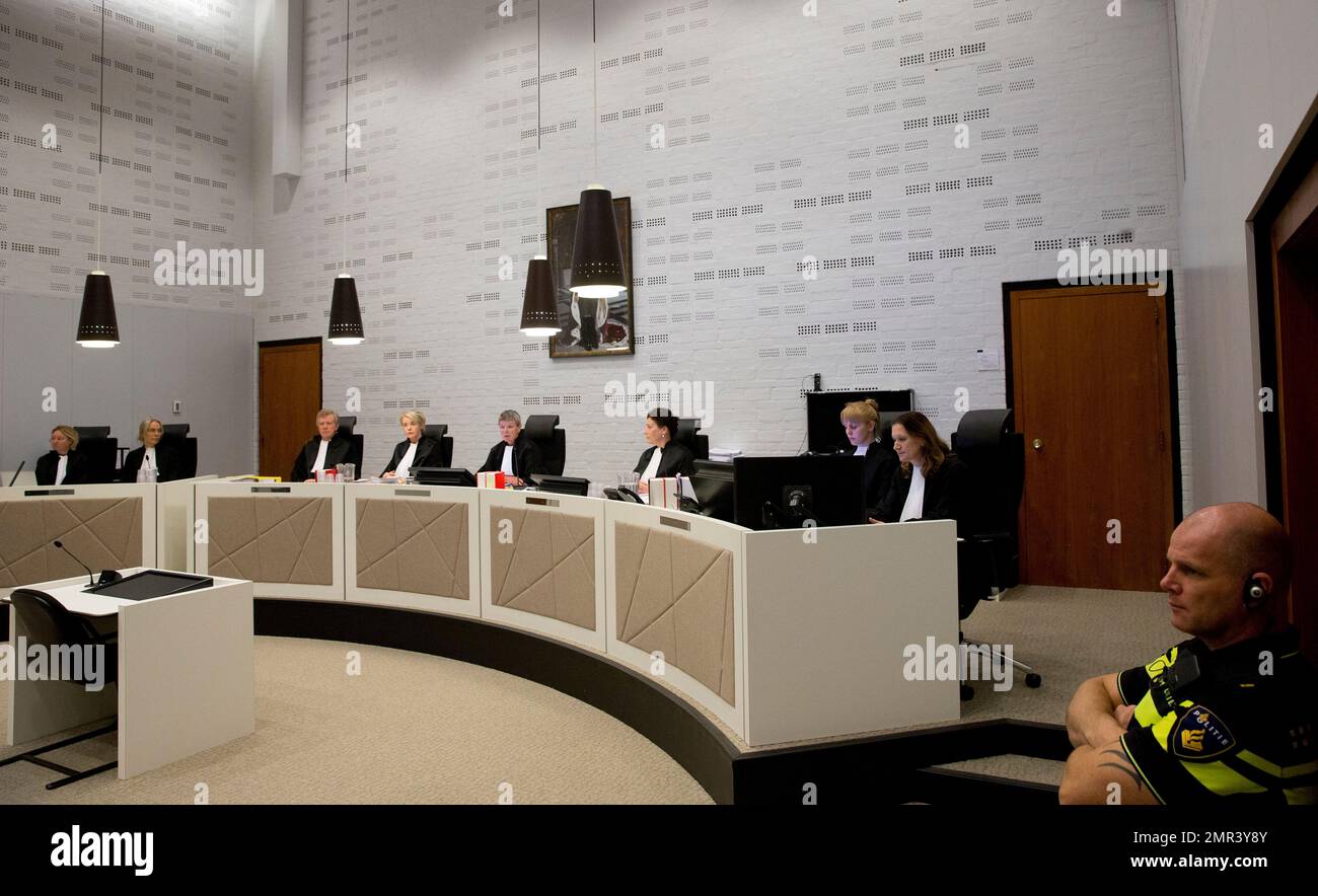 Presiding Judge Renckens, center, opens the court session in The Hague ...
