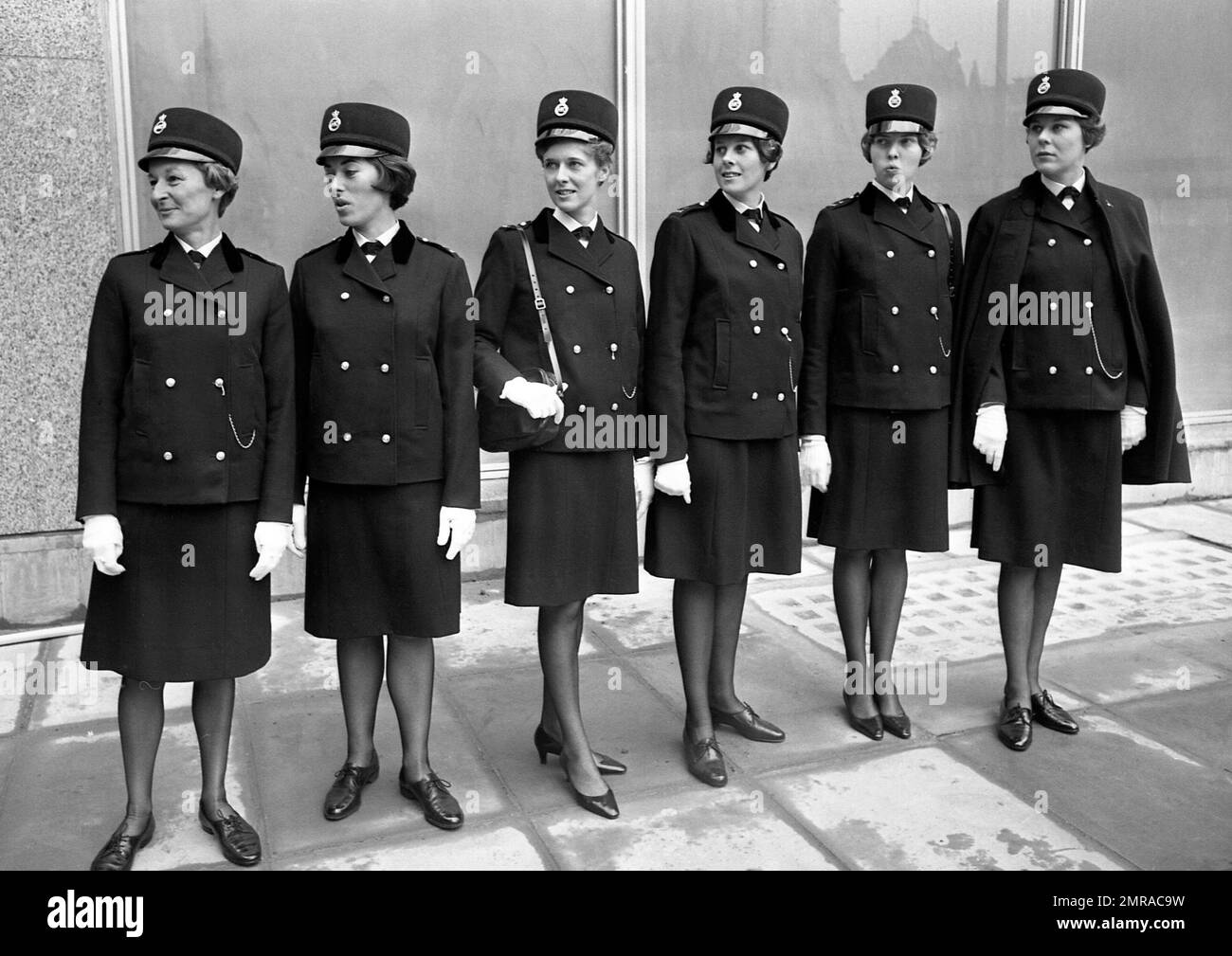 Standing in the foreground of New Scotland Yard, London, are six London ...