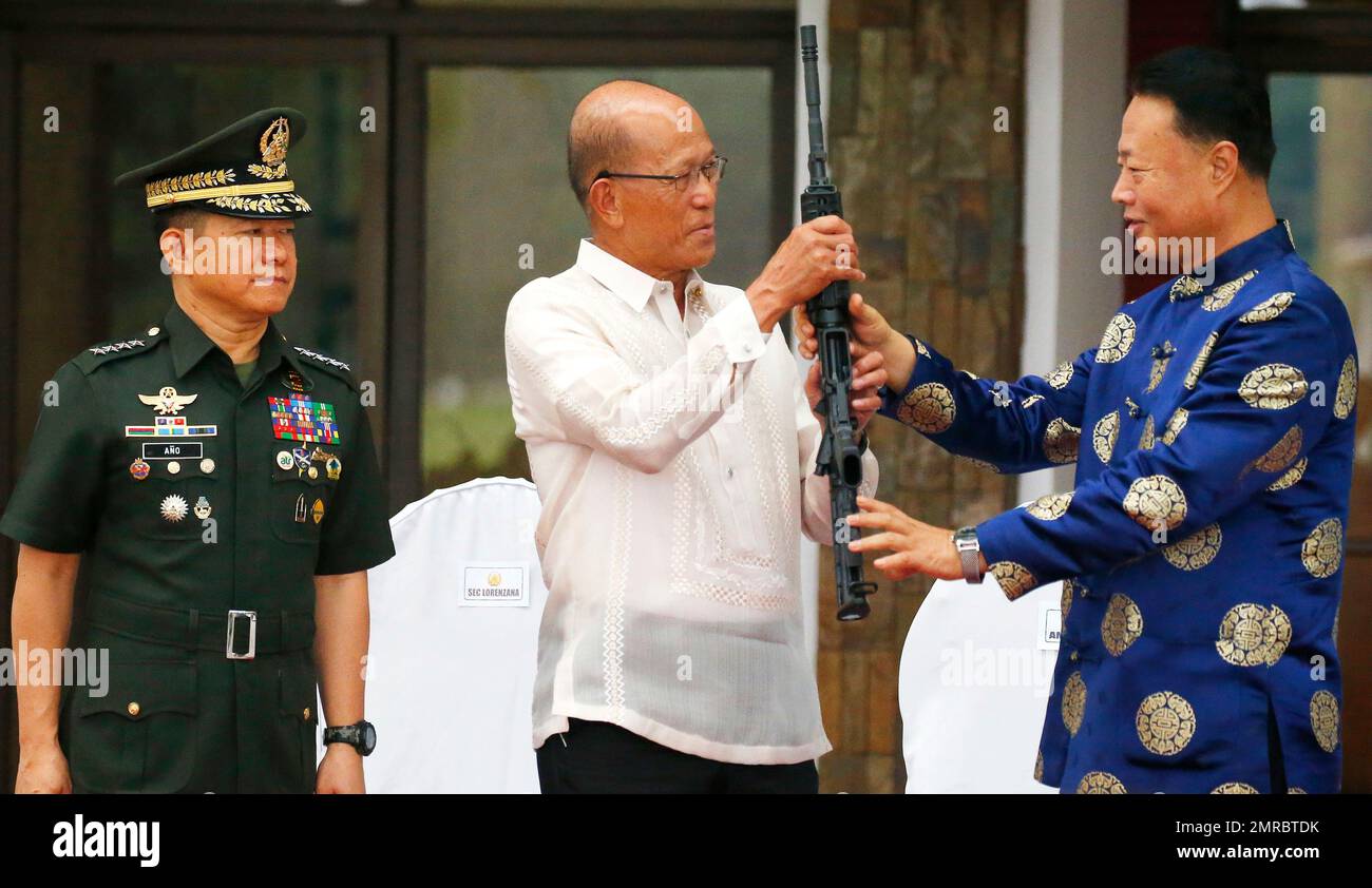 Chinese Ambassador to the Philippines Zhao Jianhua, right, hands a ...