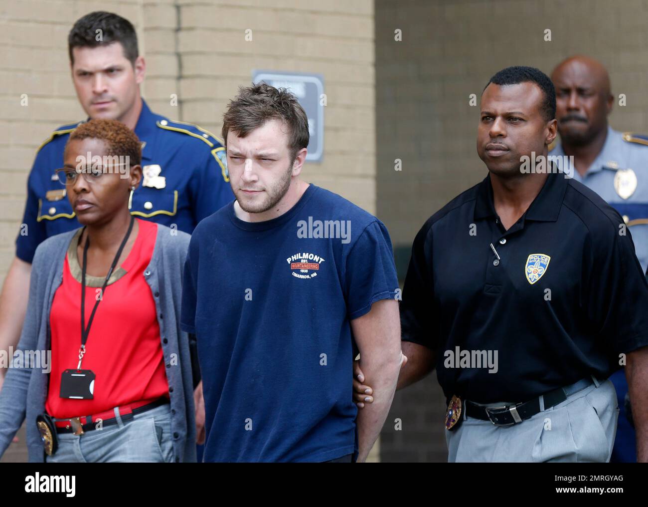 Kenneth James Gleason is escorted by police to a waiting police car in ...