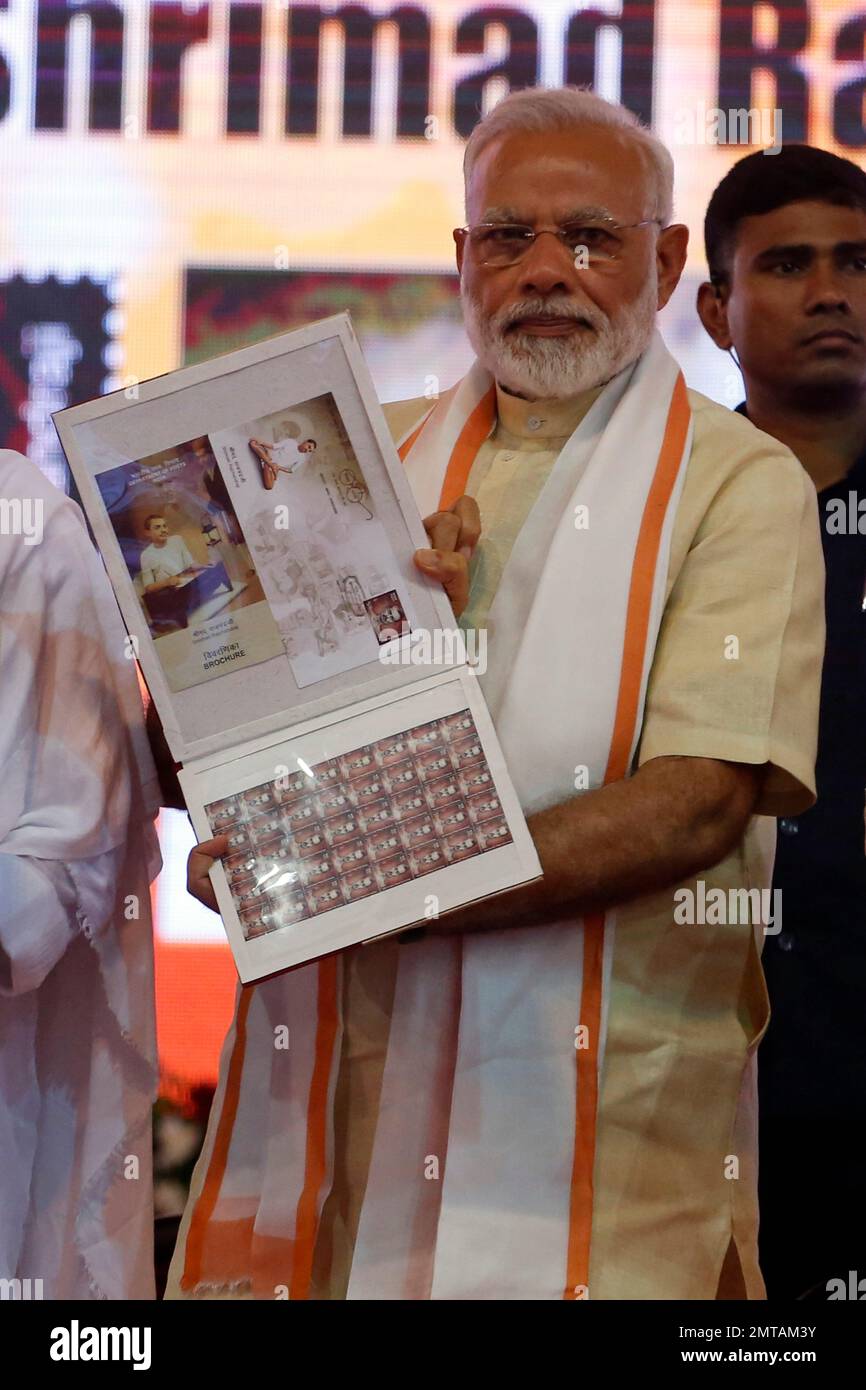 Indian Prime Minister Narendra Modi releases a commemorative postal stamp honoring Shrimad ...