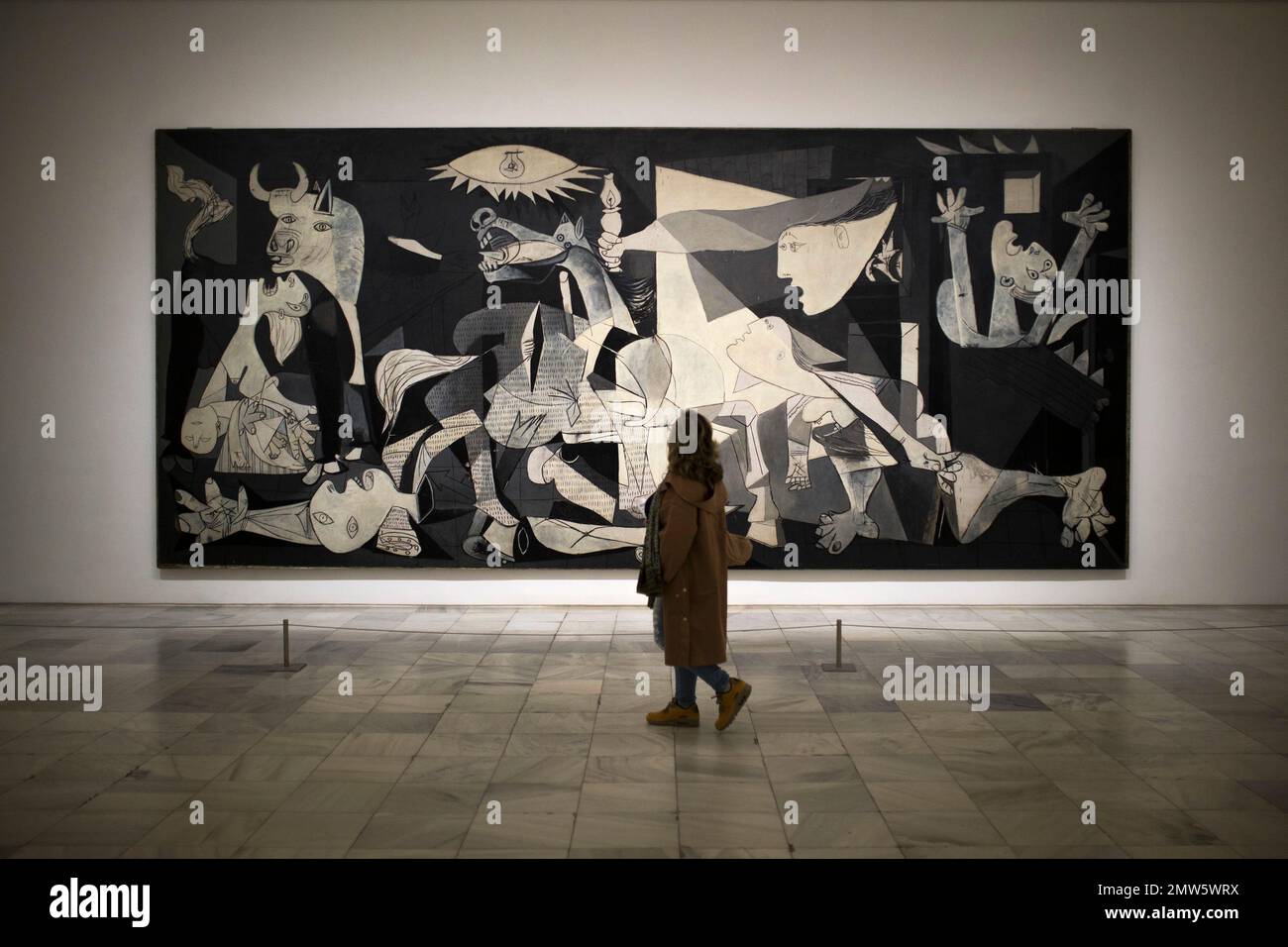 A woman looks at the "Guernica" painting by Spanish artist Pablo ...