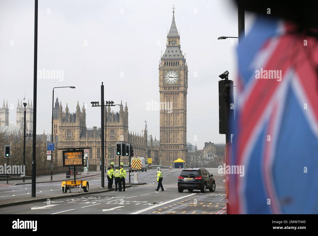 Police work at Westminster Bridge with the Houses of Parliament in ...