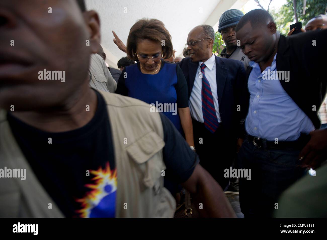 Former Haitian President Jean-Bertrand Aristide, center back, walks ...