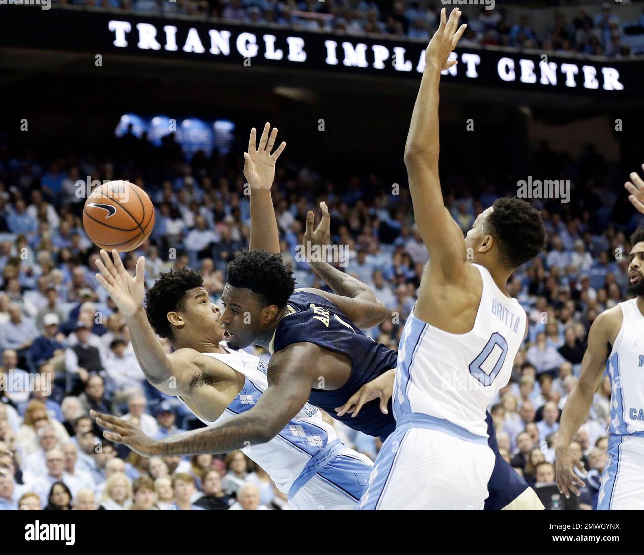 North Carolina's Isaiah Hicks, left, and Nate Britt (0) defend ...