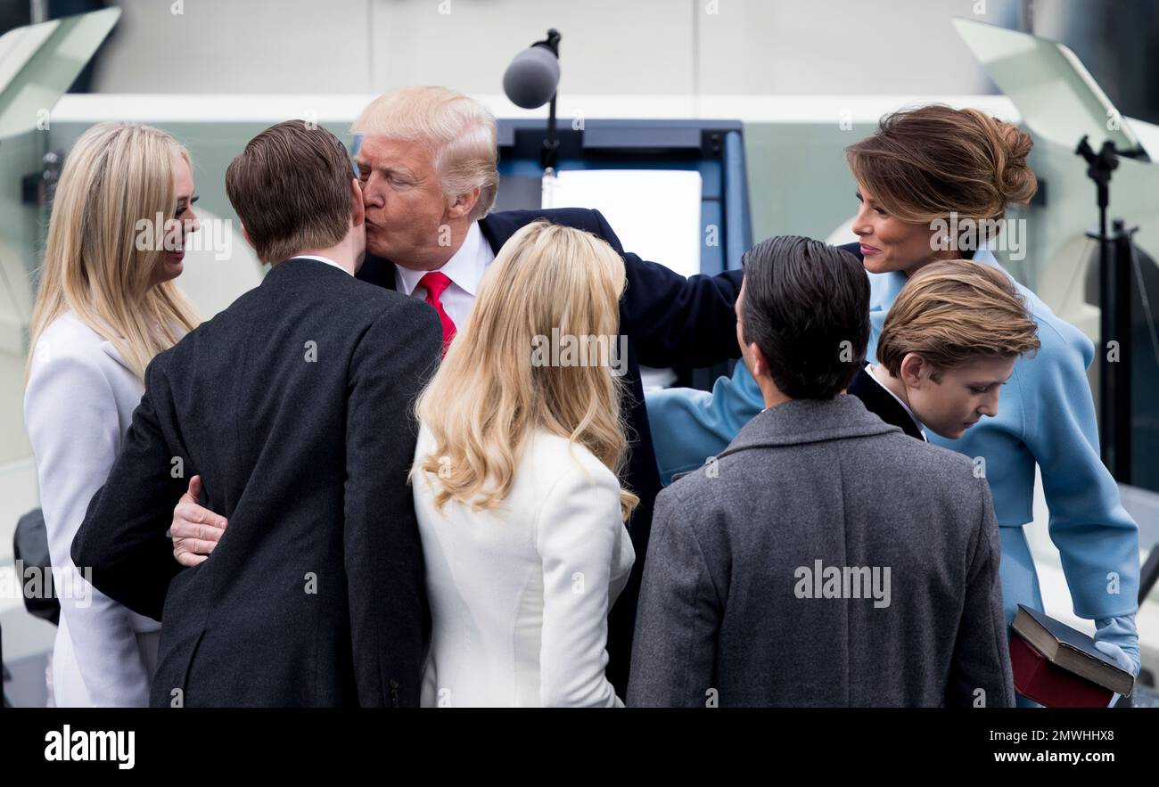Donald Trump is embraces his family after being sworn in as the 45th ...