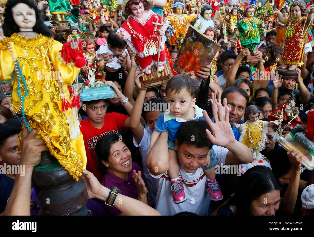 Roman Catholic devotees raise their images of the Child Jesus to be ...