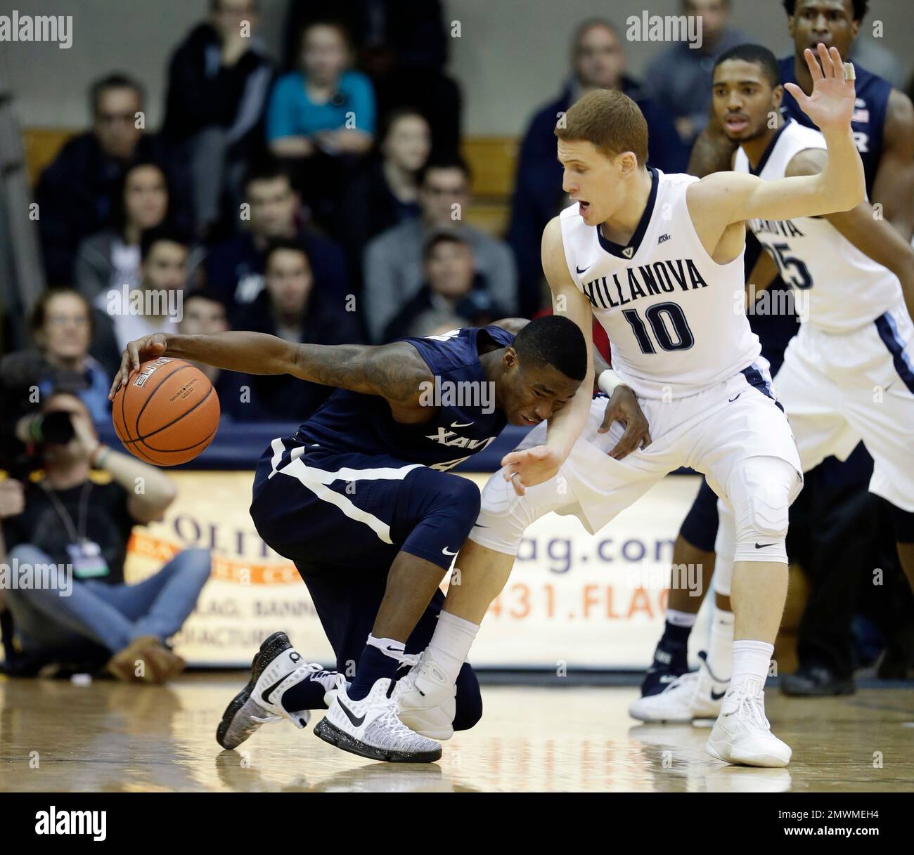 Xavier's Edmond Sumner, left, tries to get past Villanova's Donte ...