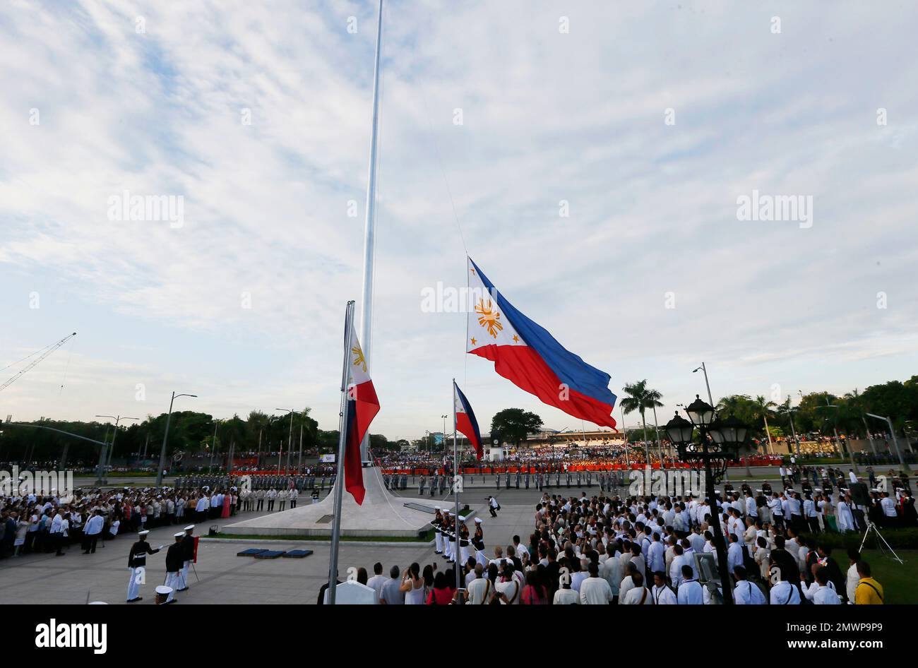 A Philippine flag is raised by top government officials led by ...