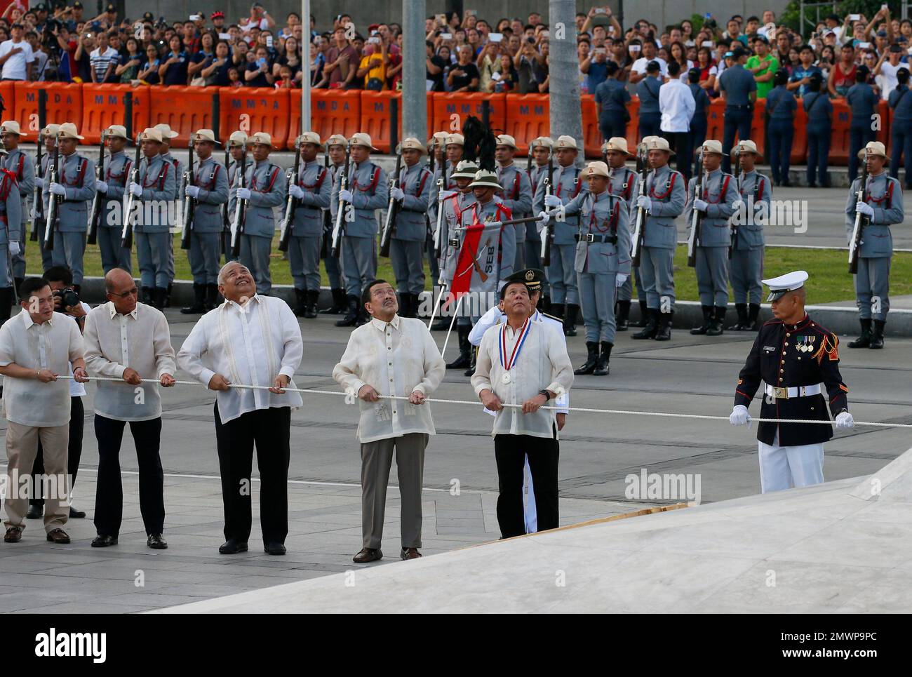 Philippine President Rodrigo Duterte, fifth from left, looks up as he ...