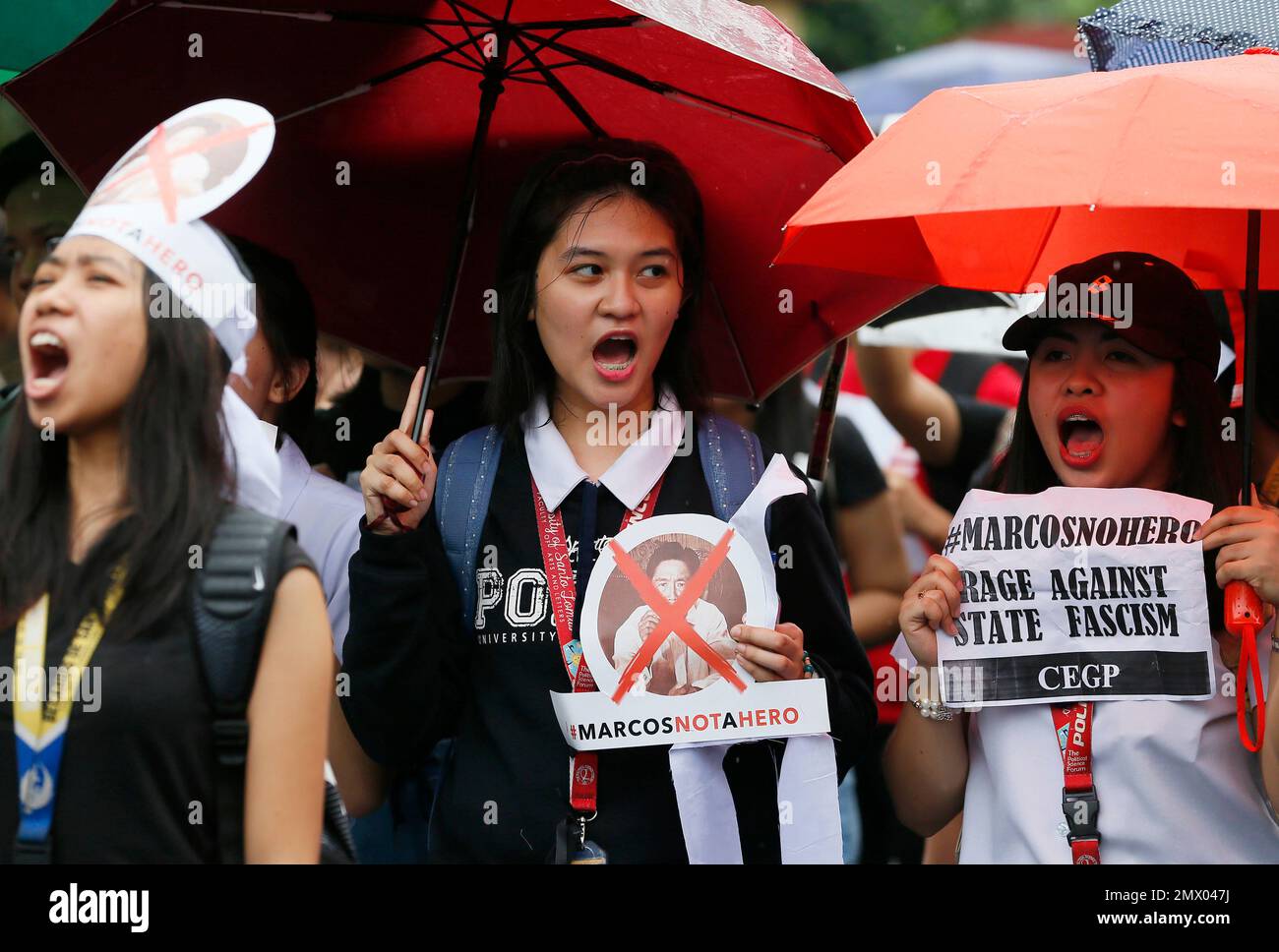 Students shout slogans as they burn an effigy of the late Philippine ...