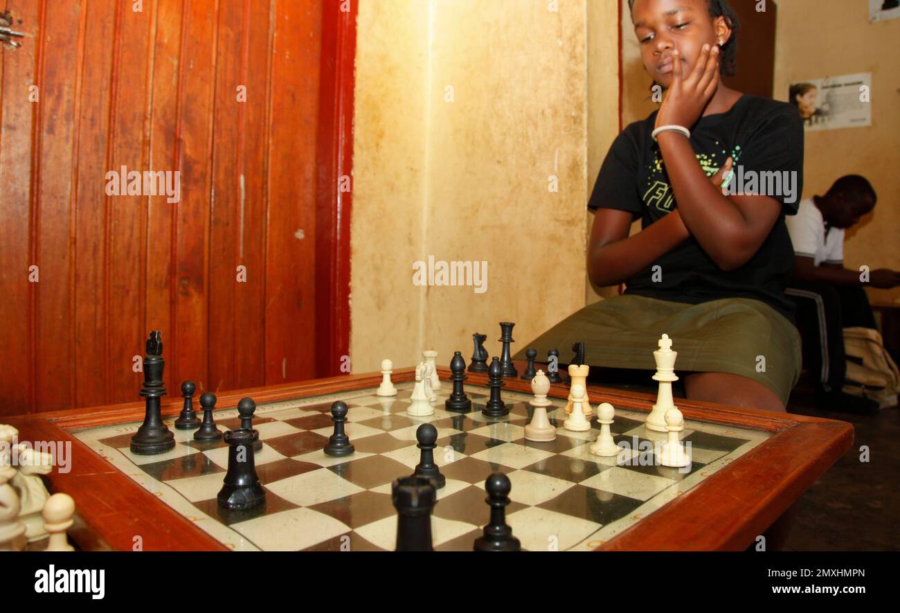 In this photo taken Friday, Oct. 14, 2016, a Ugandan girl plays chess ...