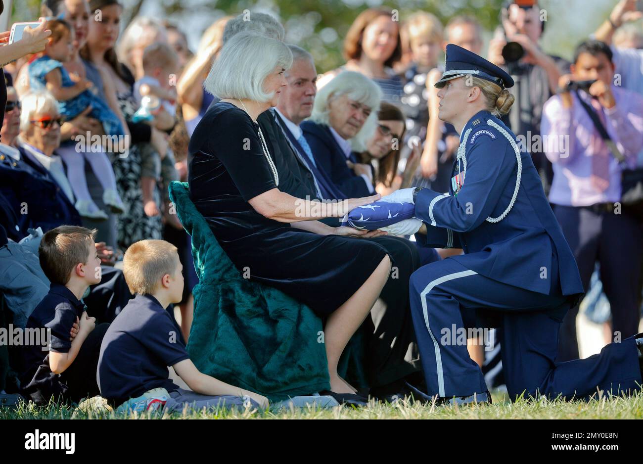 Air Force Capt. Jennifer Lee, right, kneels as she presents an American ...