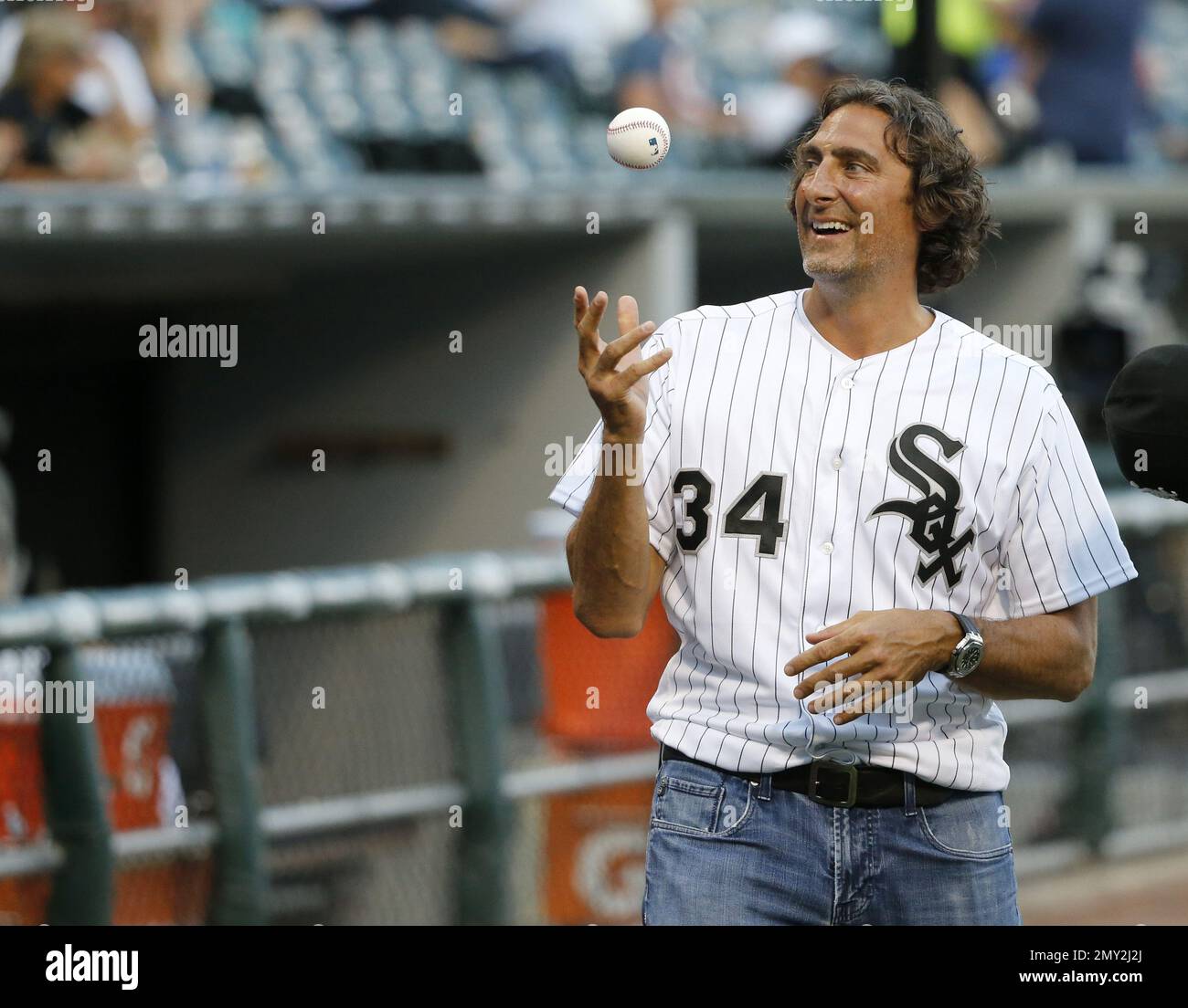 Victor Ciardelli, CEO and founder of Guaranteed Rate, tosses the ball ...