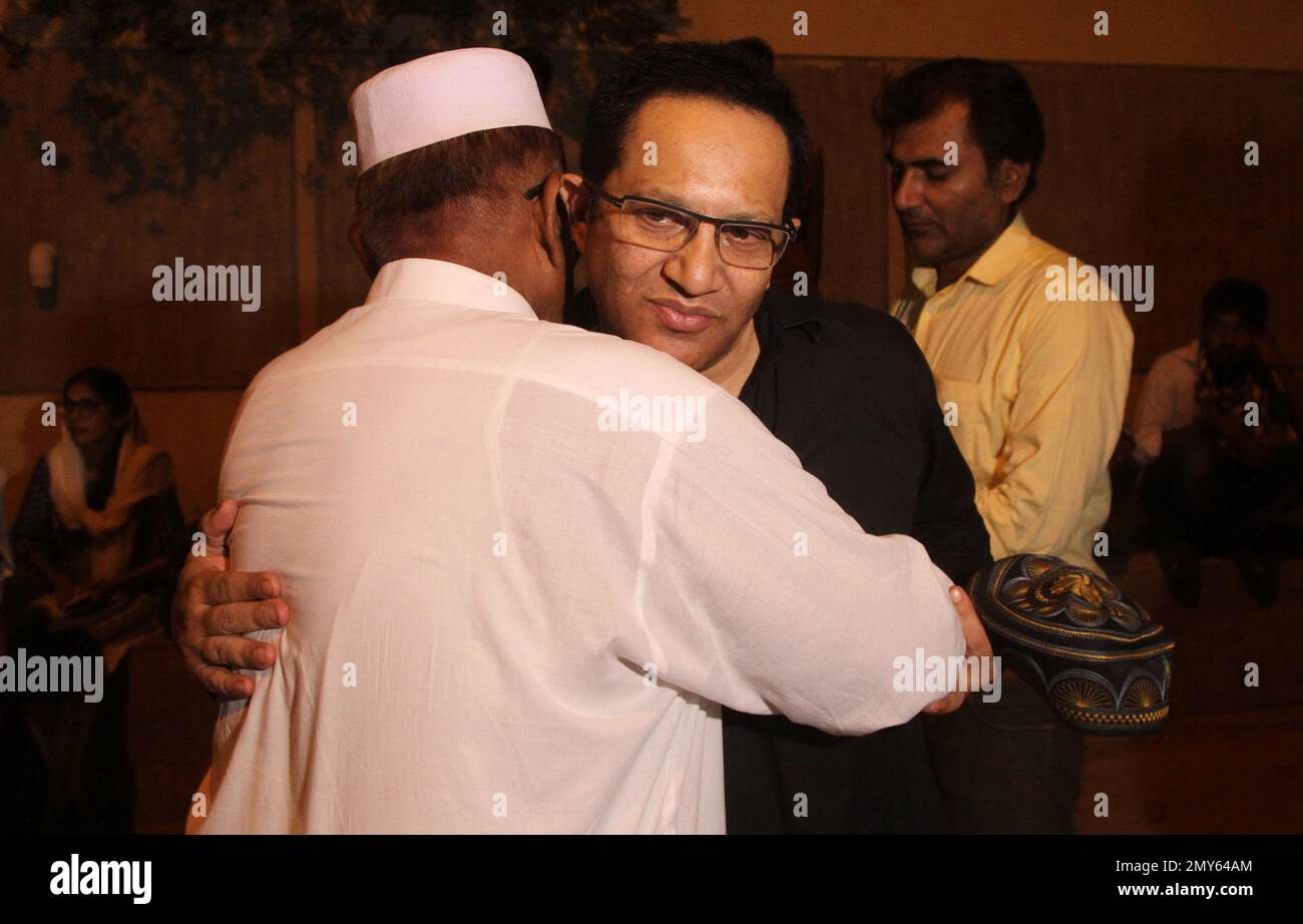 Pakistan's former cricketer Shoaib Mohammad, centre, is comforted by ...