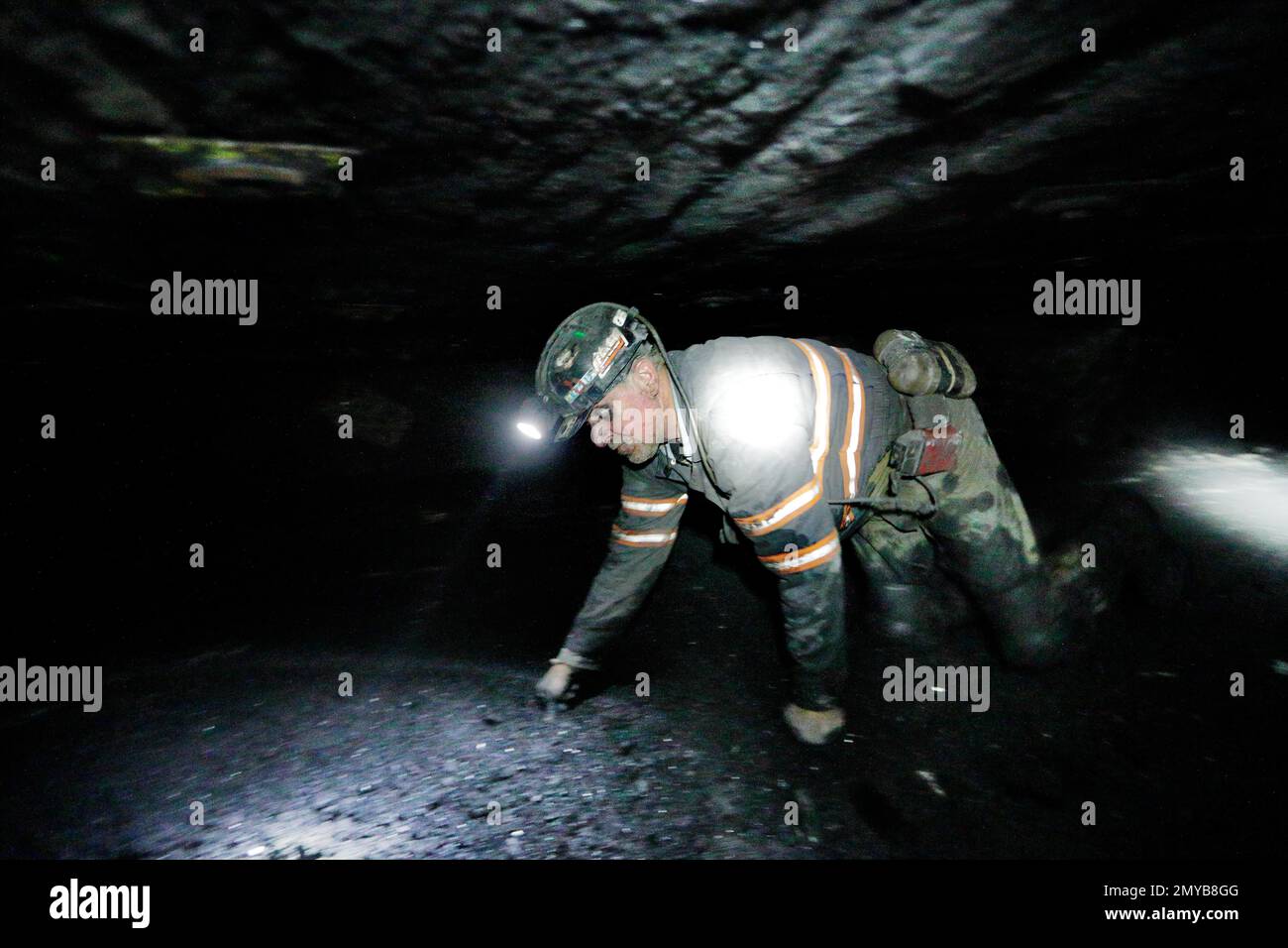 CLIMATE CHANGE: Coal miner Scott Tiller crawls through an underground ...