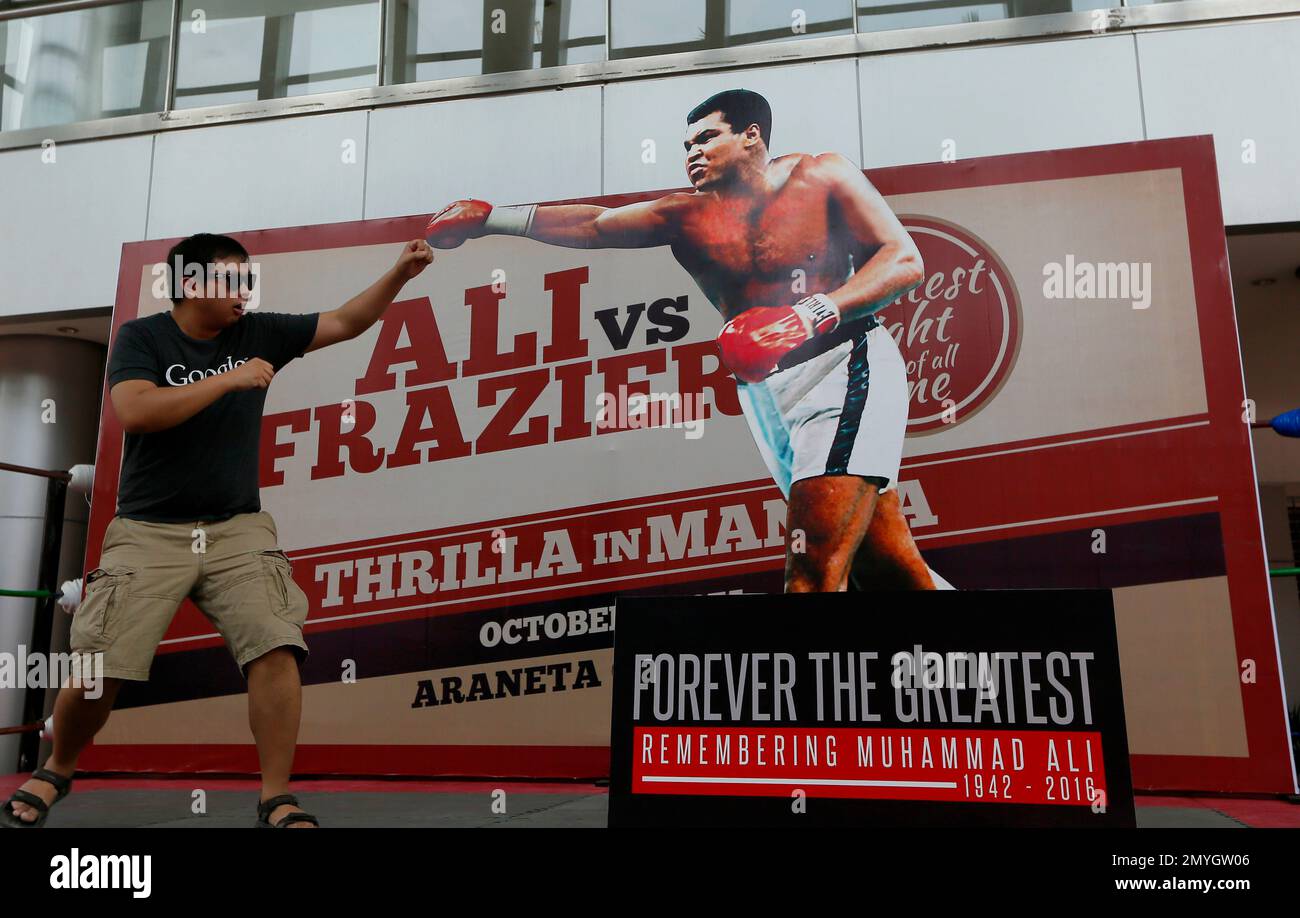 Romy Doria poses before a standee of Muhammad Ali during the launch of ...