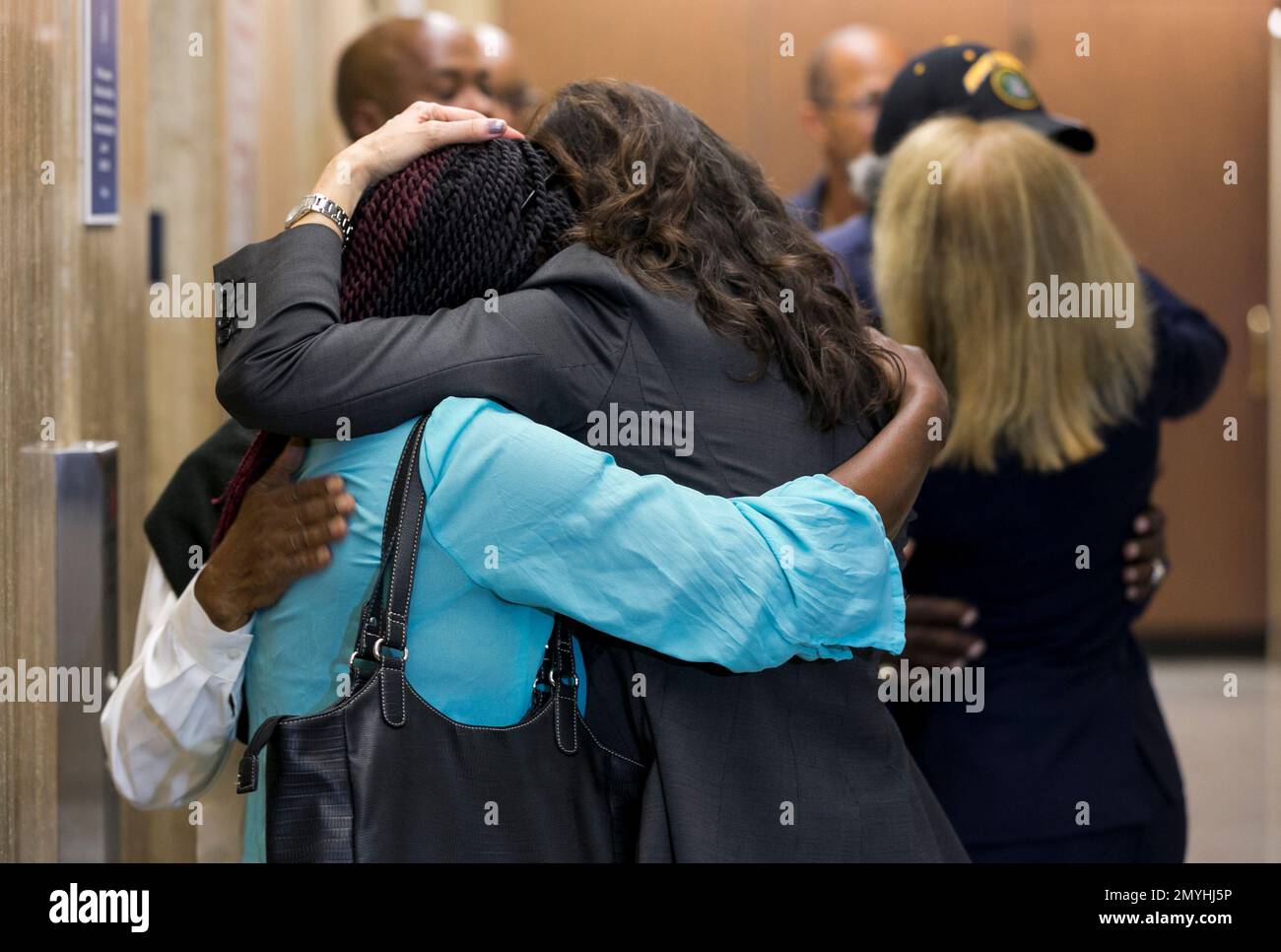 Deputy District Attorney Beth Silverman, second from left, hugs family ...