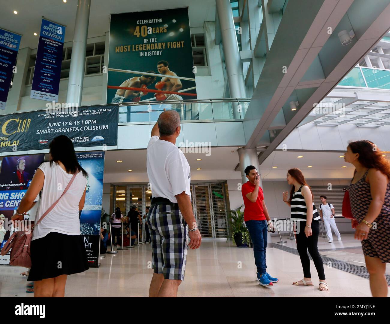 A man points to the huge billboard heralding the 1975 "Thrilla-in ...