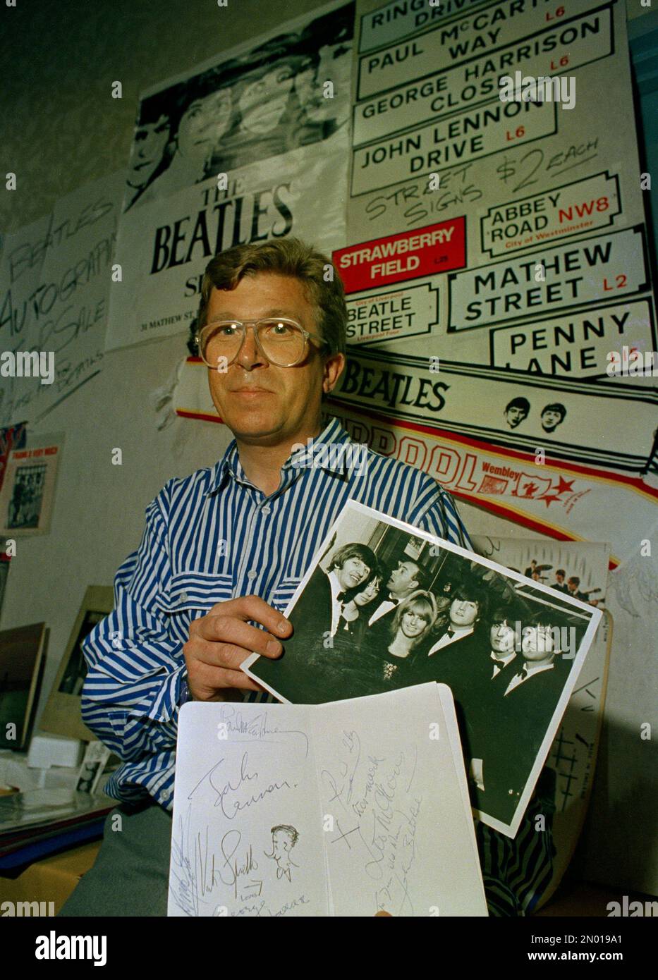 Ian Wallace, owner of The Beatles Shop of Liverpool, shows off two of ...