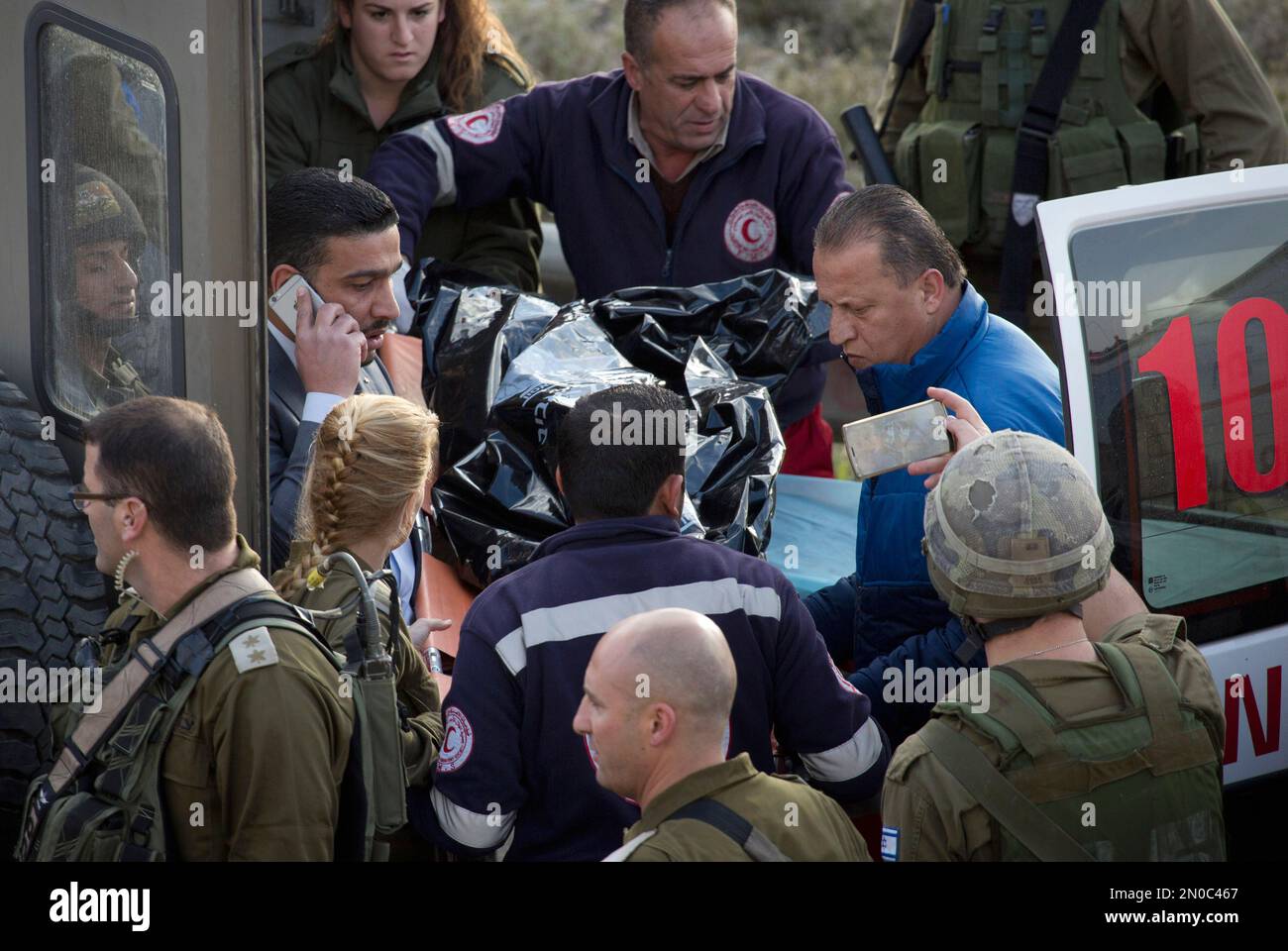 Palestinian paramedics move the body of Haytham al-Baw, 14, to the ...