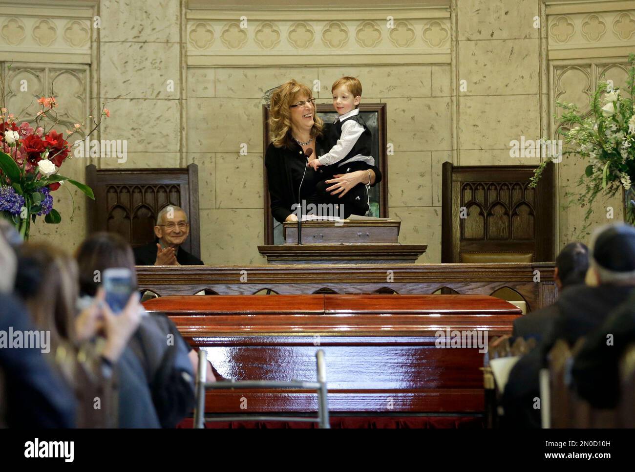 Abe Vigoda's daughter Carol Vigoda-Fuchs speaks while holding his great ...