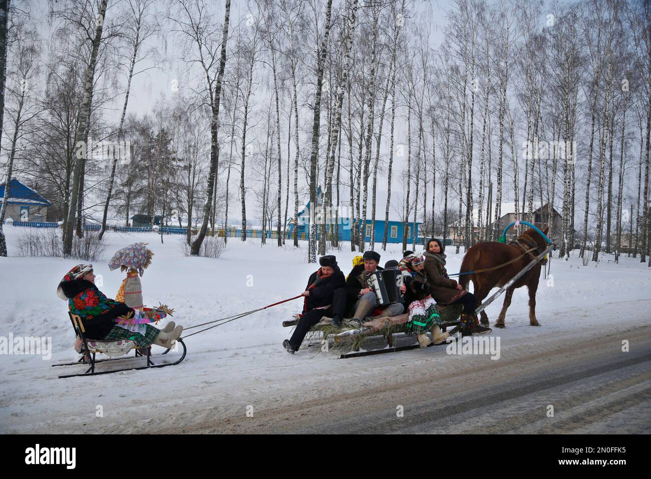 Belarusians, some wearing national costumes, ride in sleighs during the ...