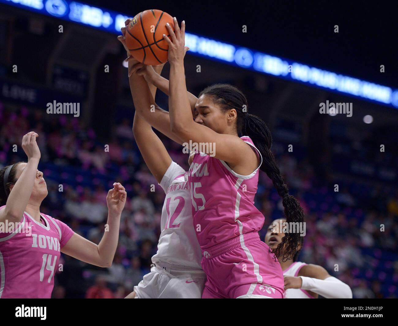 Iowa's Hannah Stuelke (45) battles for a rebound with Penn State's ...