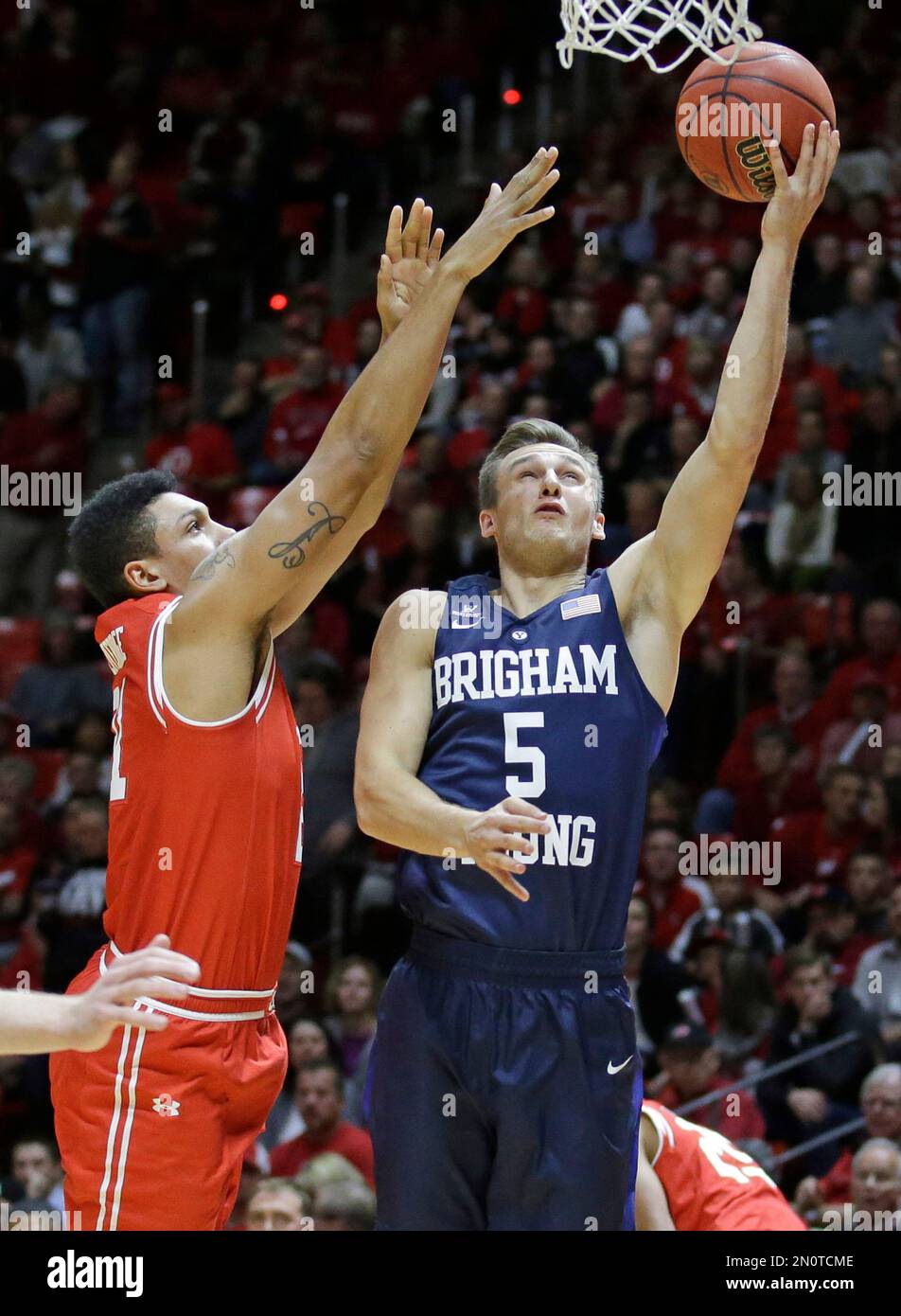 BYU guard Kyle Collinsworth (5) lays the ball up as Utah forward Jordan ...