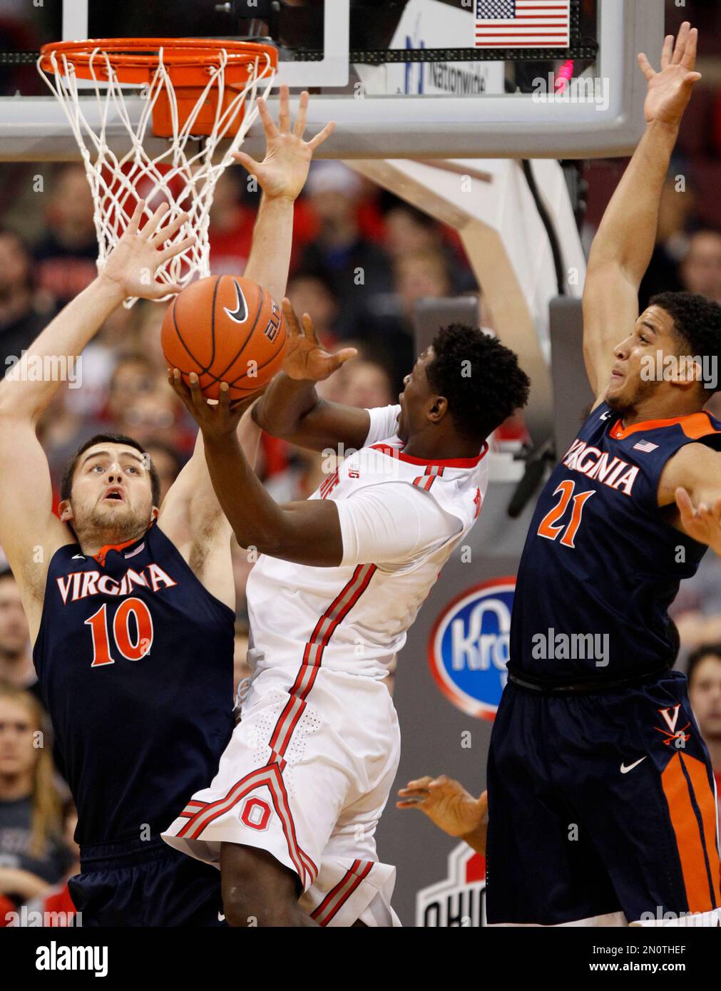 Ohio State's Jae'Sean Tate, center, goes up for a shot between Virginia ...
