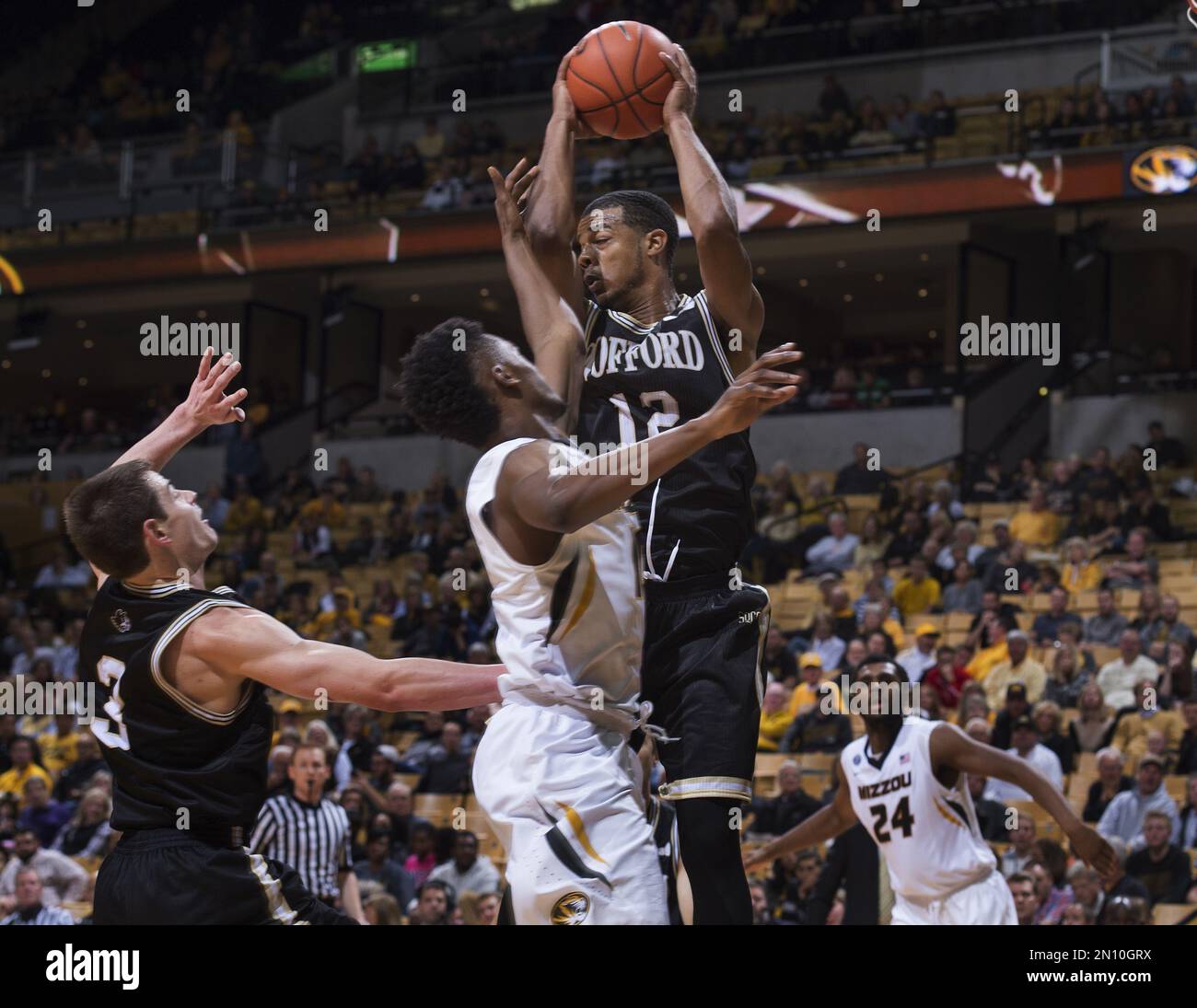 Wofford's Spencer Collins, top, pulls down a rebound over Missouri's K ...