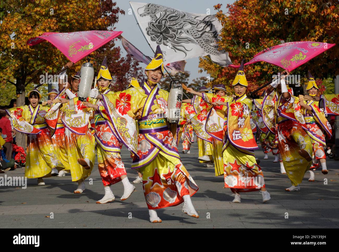 Participants perform as they parade through Tokyo streets during an ...