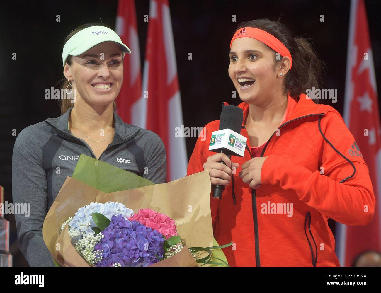Sania Mirza of India, right, accompanied by her partner Martina Hingis ...